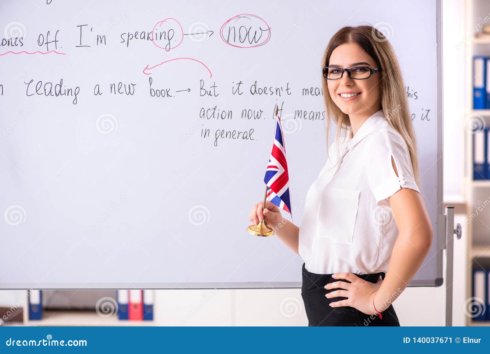 The Young Female English Language Teacher Standing in Front of the ...