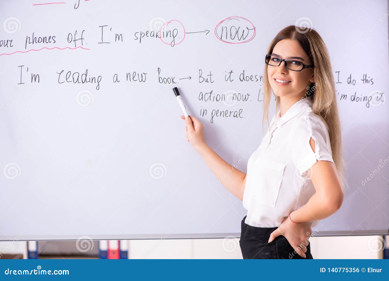 The Young Female English Language Teacher Standing in Front of the ... The Young Female English Language Teacher Standing in Front of the ...