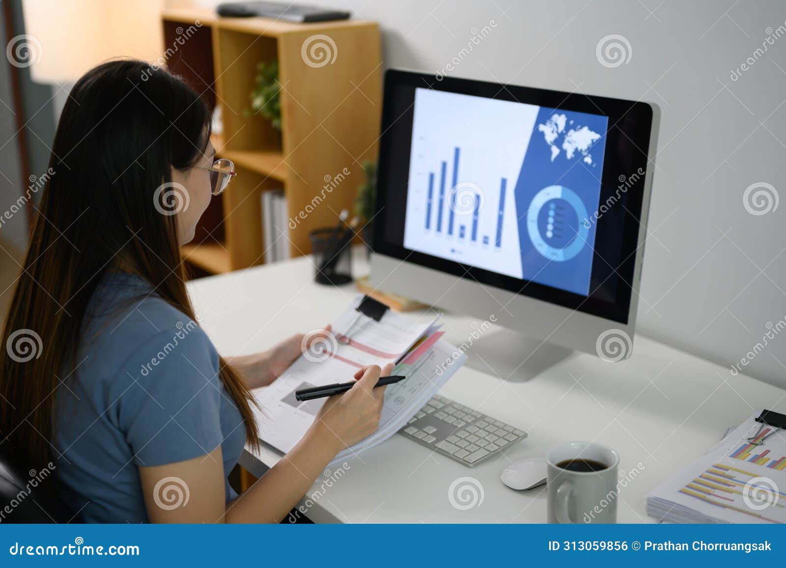 Young Female Entrepreneur Working at Home with Graphs, Charts on ...
