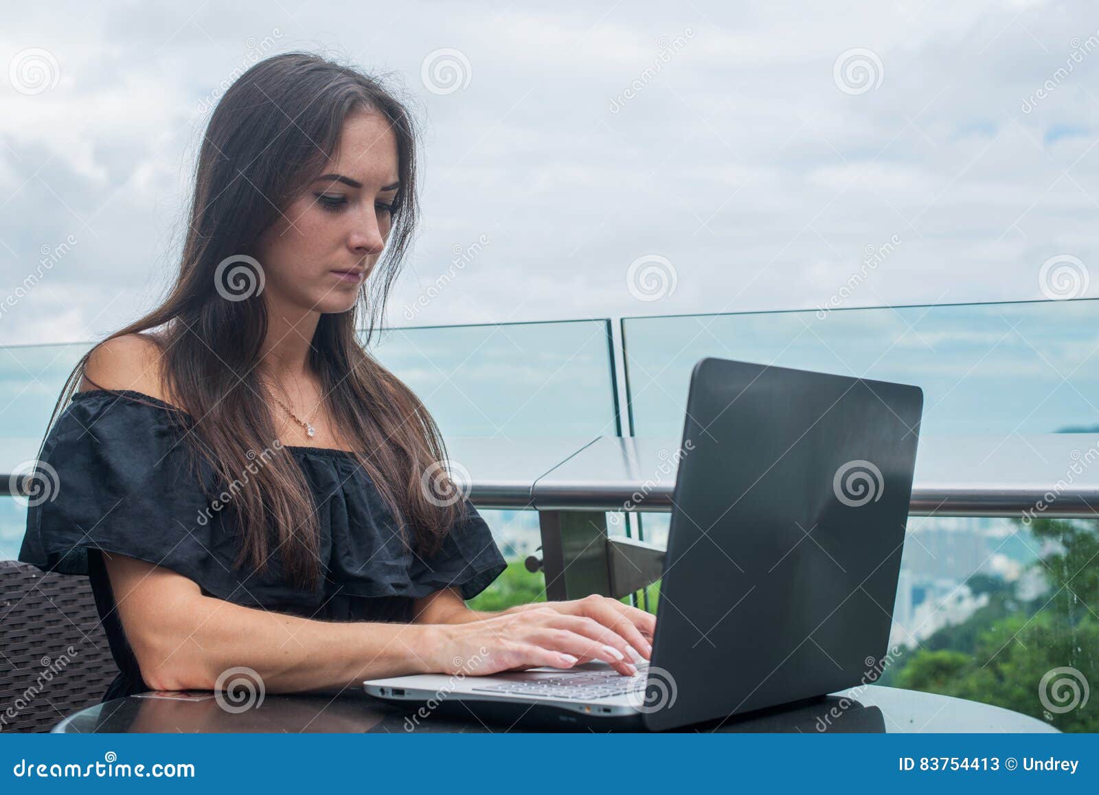 Young Female Freelancer Dressed in Black Working on a Project Laptop ...