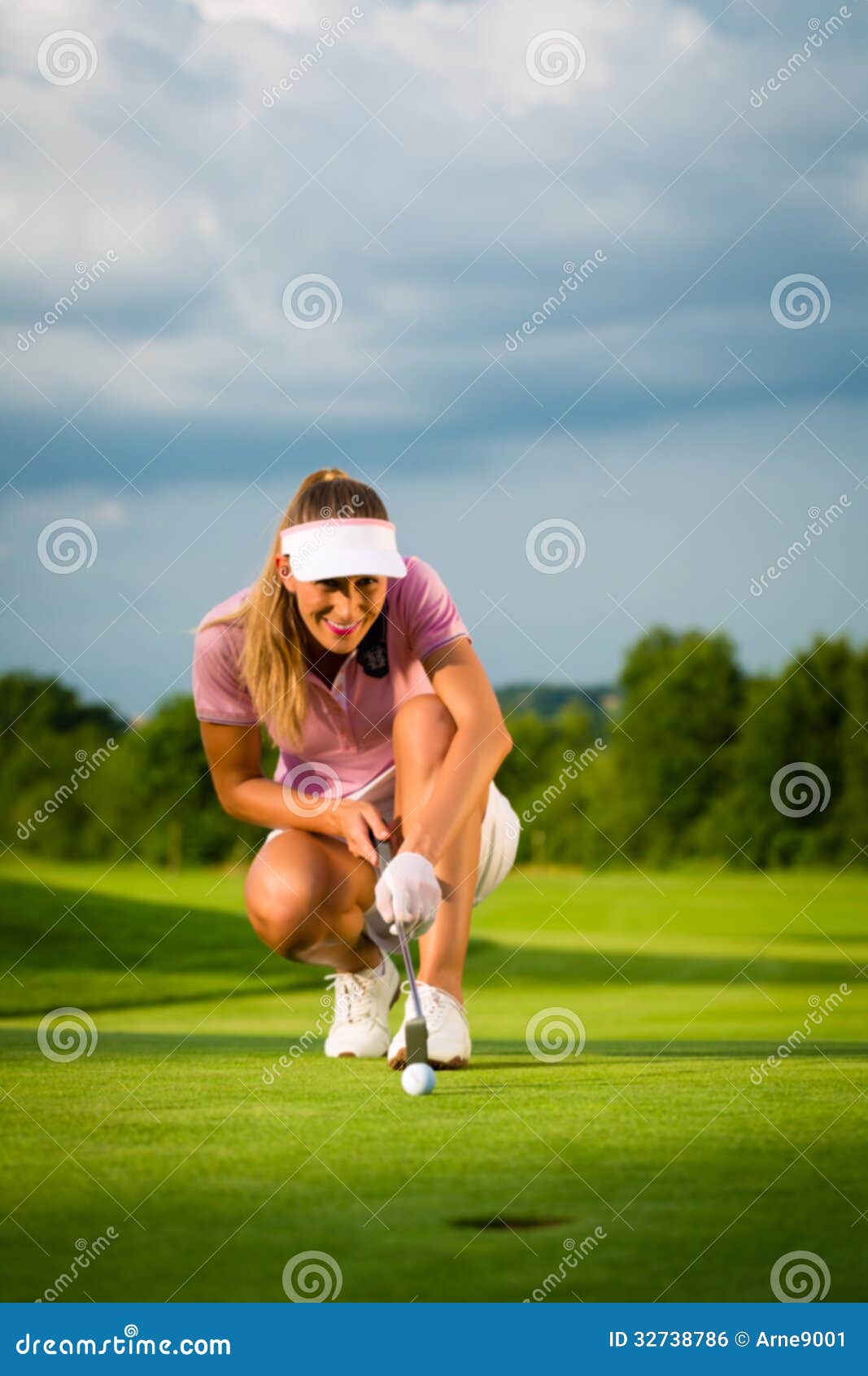 Young Female Golf Player on Course Aiming for Her Put Stock Photo ...
