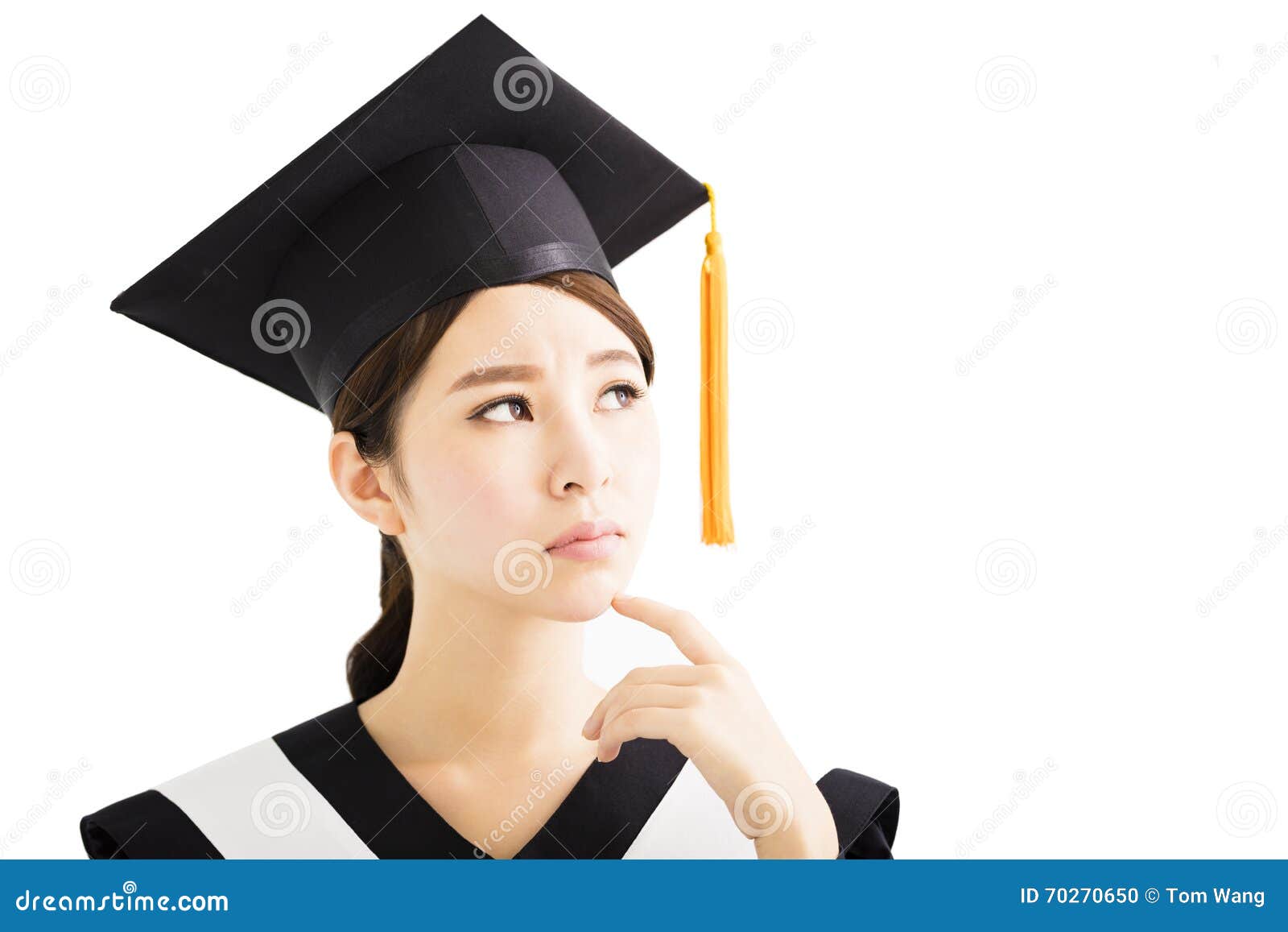 Young Female Graduation Student Looking Up and Thinking Stock Photo ...