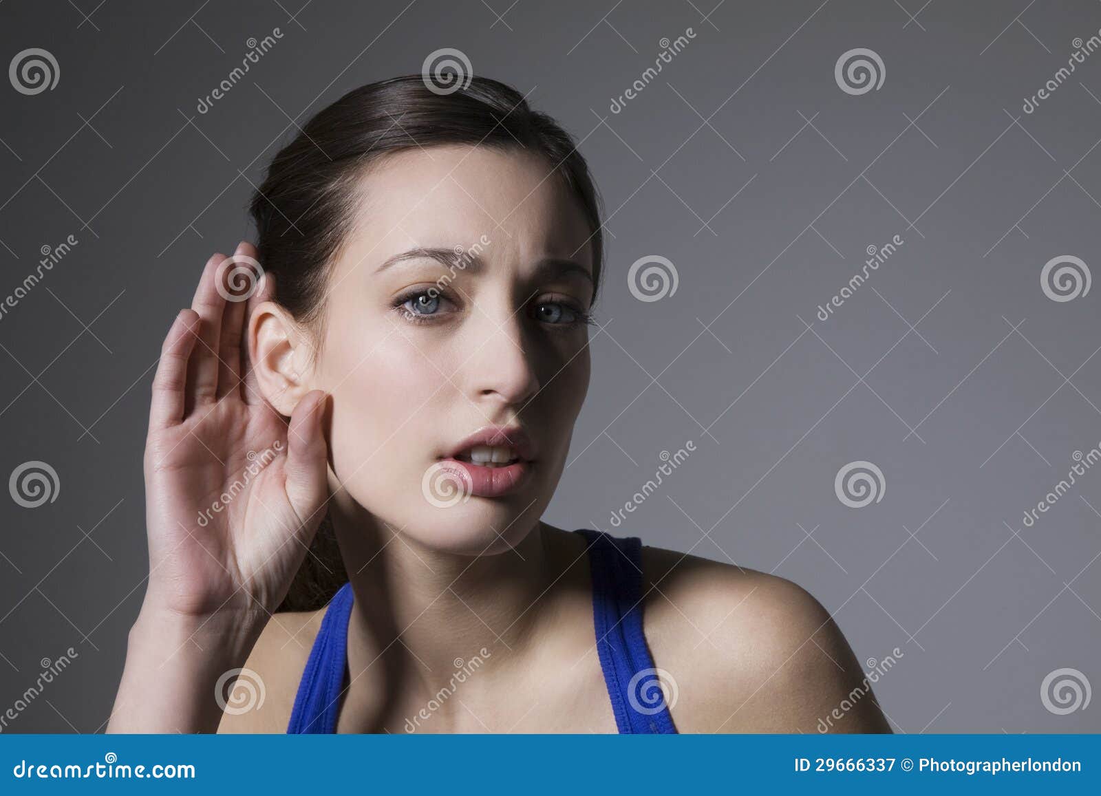 Young Female with Hand Behind Ear Stock Image - Image of expressive ...