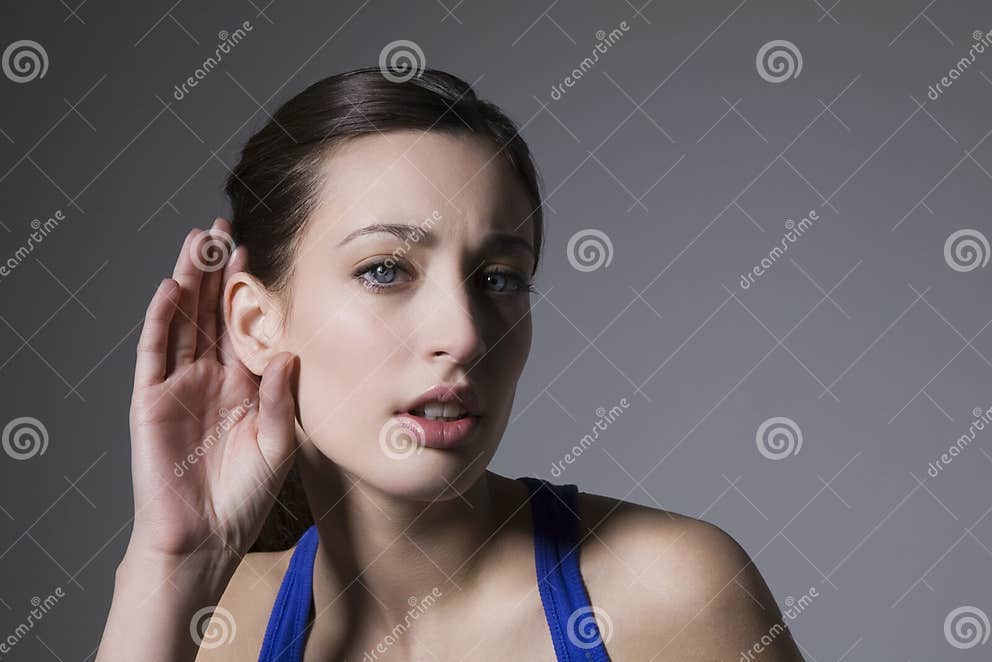 Young Female with Hand Behind Ear Stock Image - Image of expressive ...