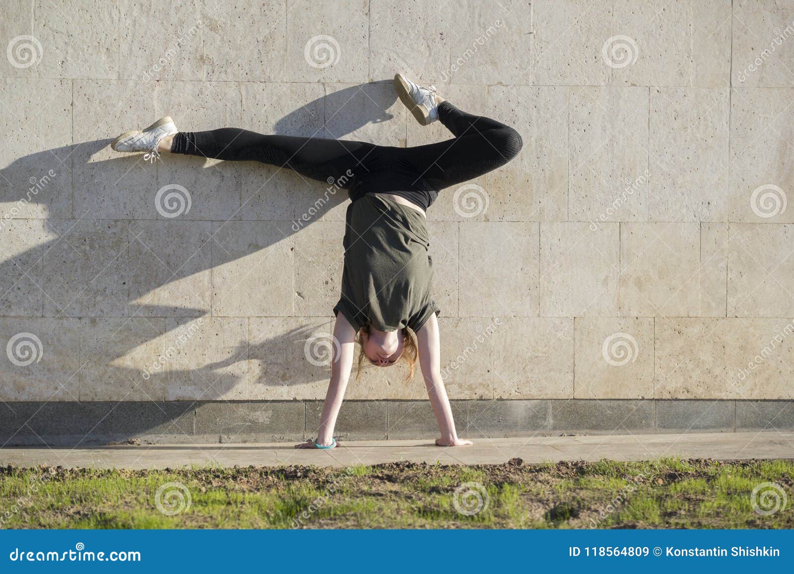 Young Female Handstand Against the Wall Performs Acrobatic Elements ...