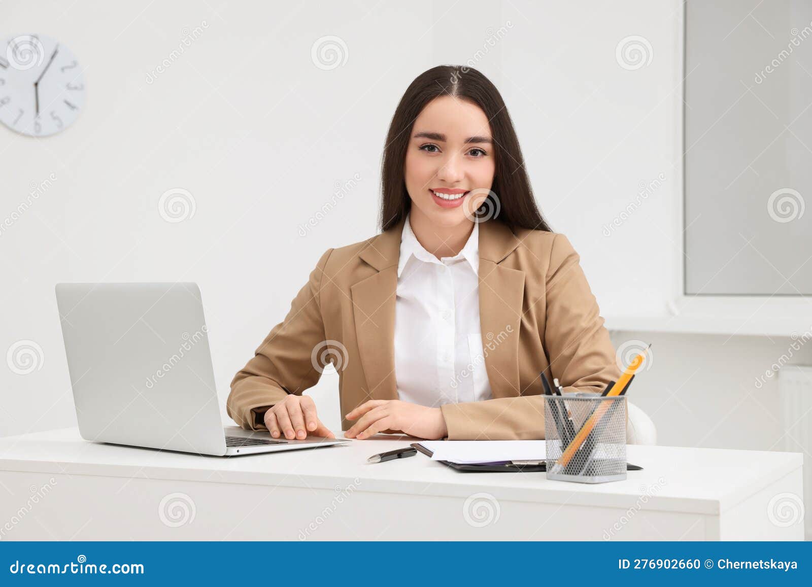 Young Female Intern Working with Laptop at Table in Office Stock Photo ...