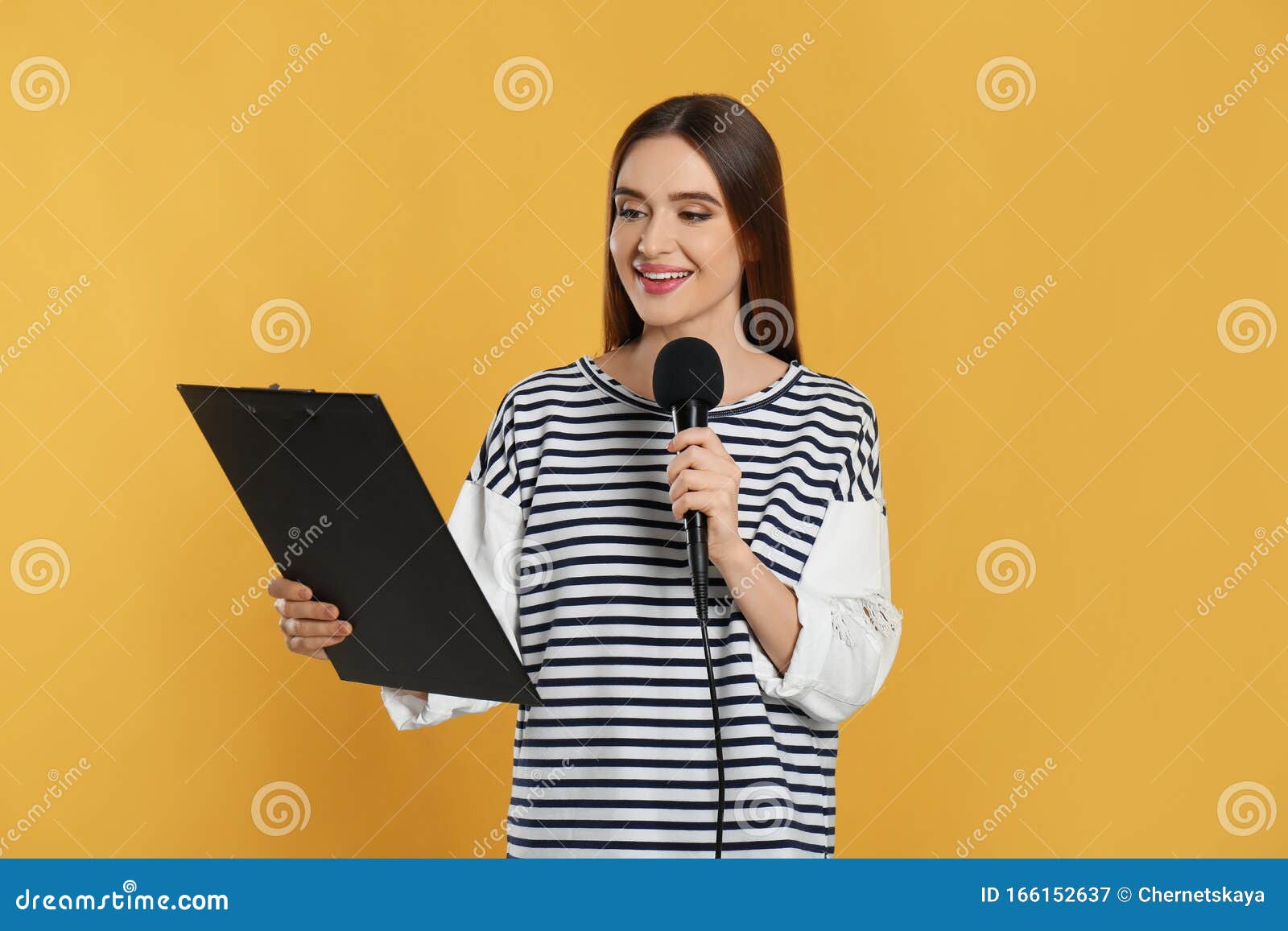 Young Female Journalist with Microphone and Clipboard Stock Image ...