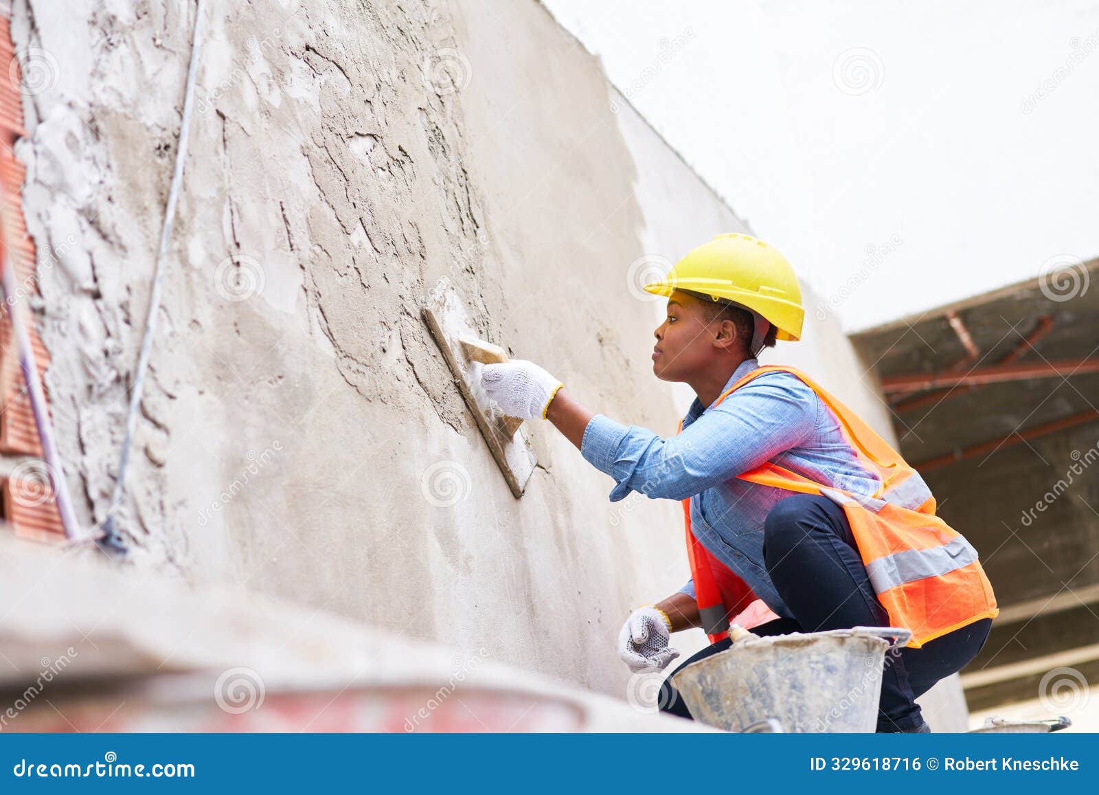Low Angle View of Young Female Labor Plastering on Wall with Cement ...