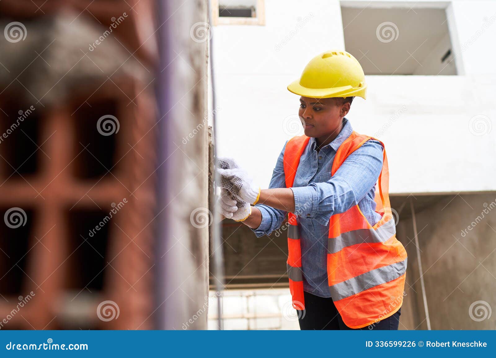 Young Female Labor Plastering on Wall with Mortar at Construction Site ...