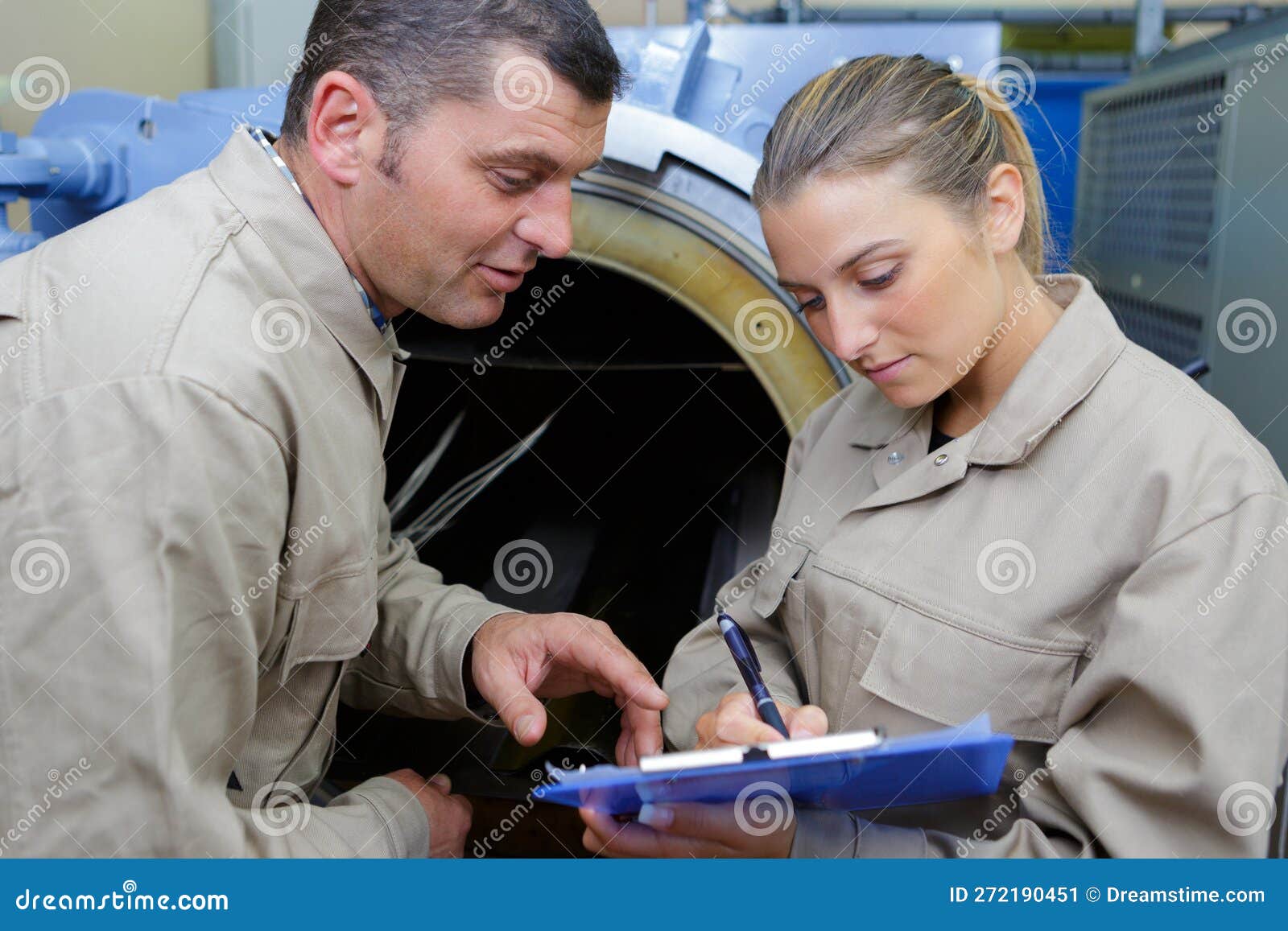Young Female Machinist Writing on Clipboard Stock Image - Image of ...