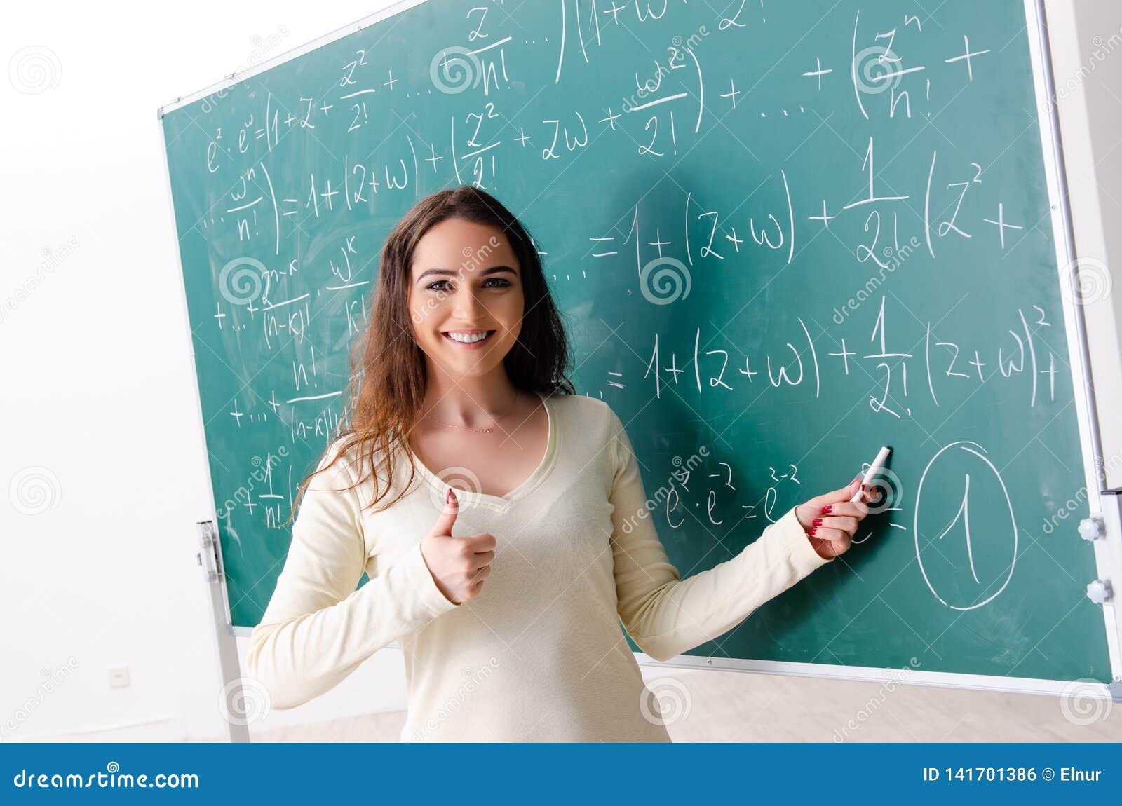 The Young Female Math Teacher in Front of Chalkboard Stock Photo ...