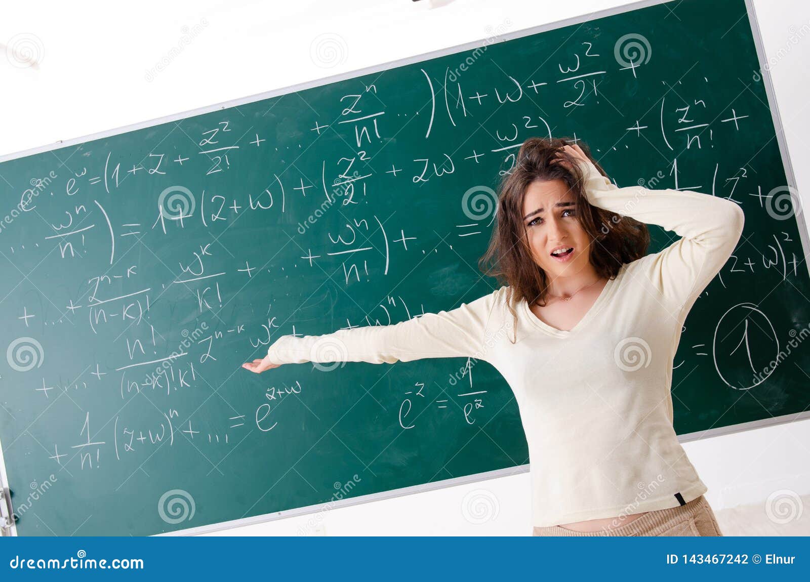 The Young Female Math Teacher in Front of Chalkboard Stock Photo ...