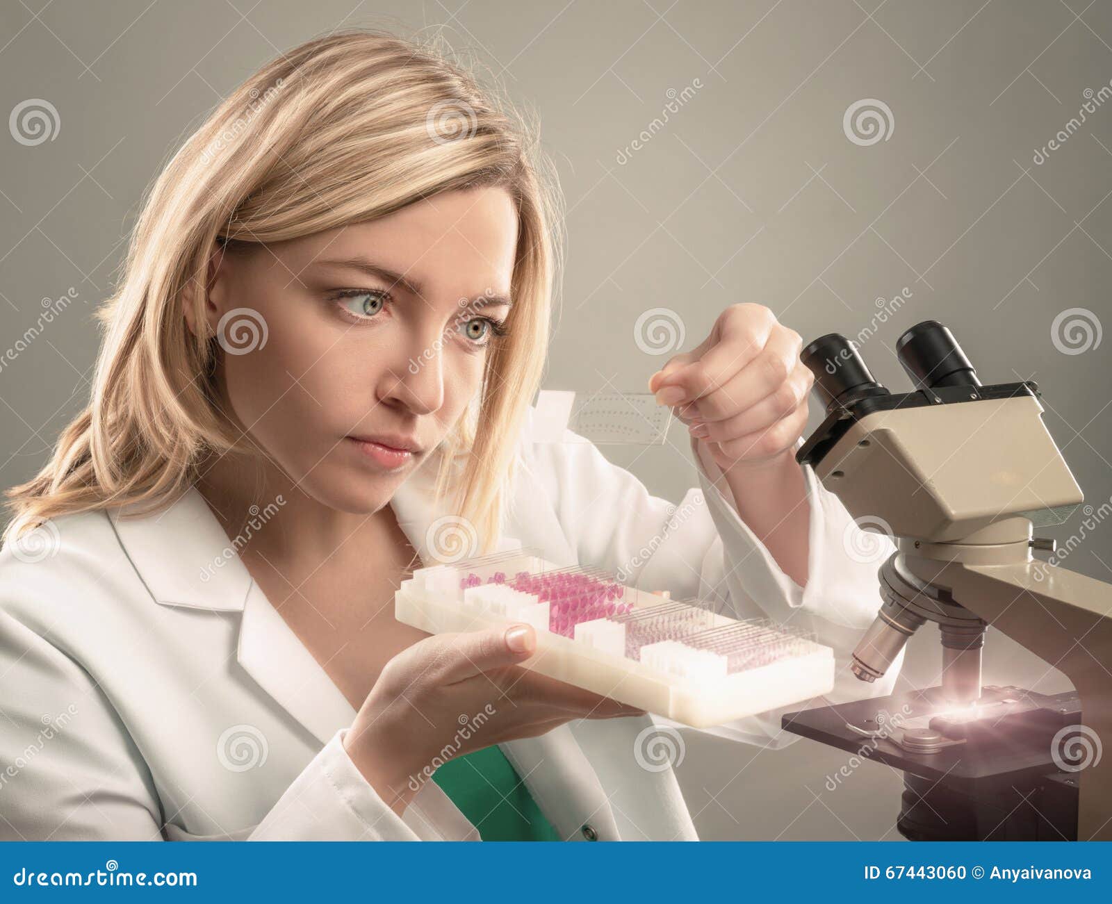 Young Female Microscopist in White Coat Selects a Tissue Sample Stock ...