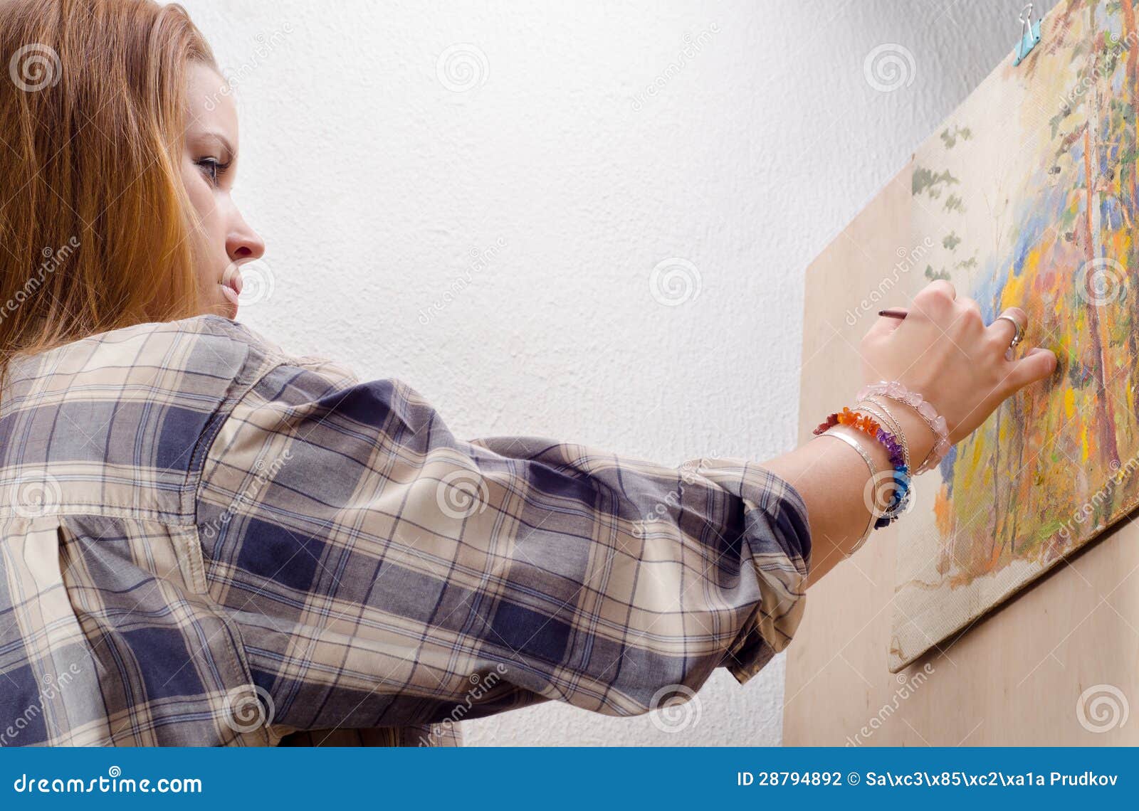 Female Painter Applying Paint On Canvas With Fingers While Creating A ...