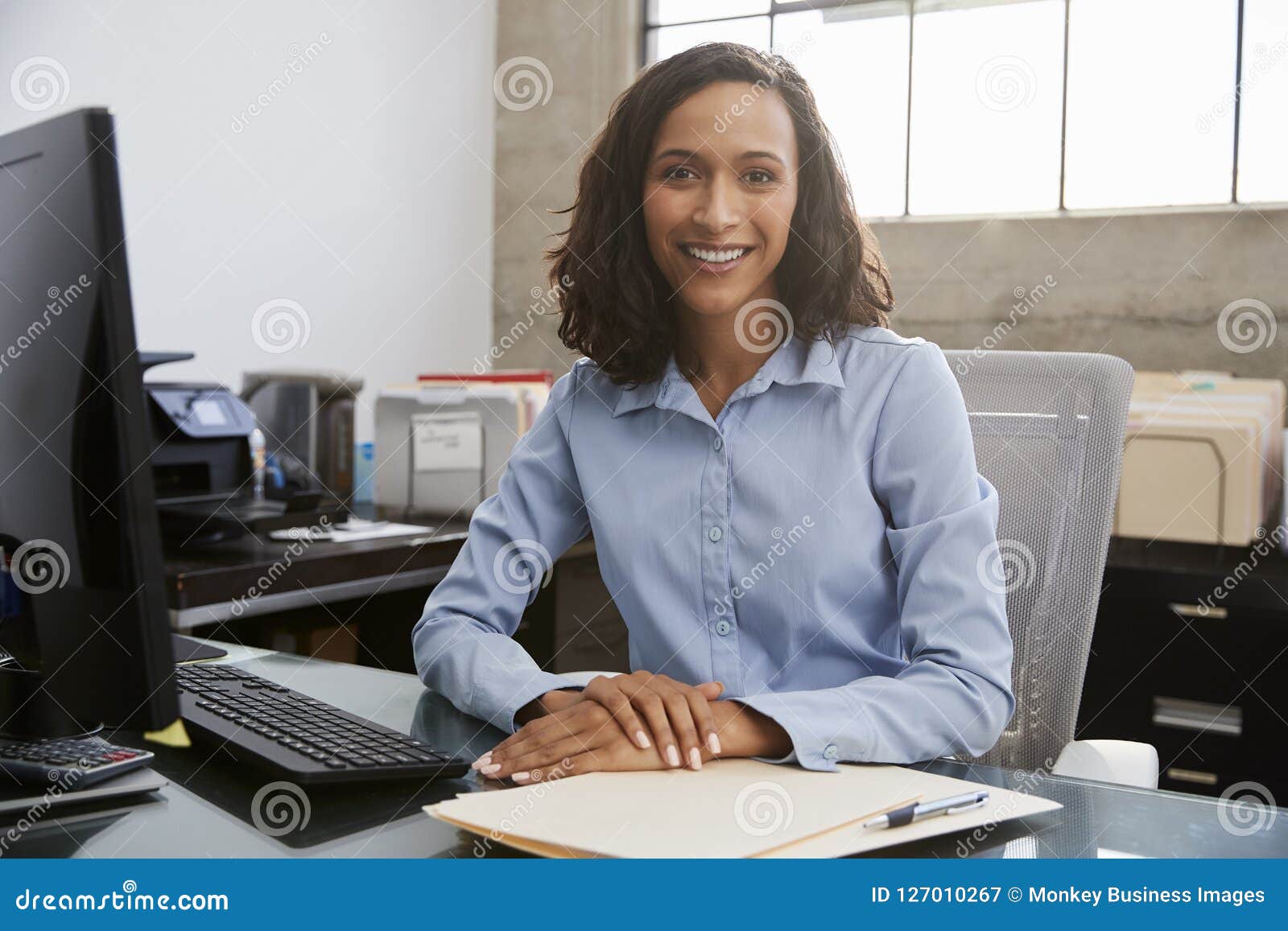Young Female Professional Sitting at Desk in an Office Stock Image ...