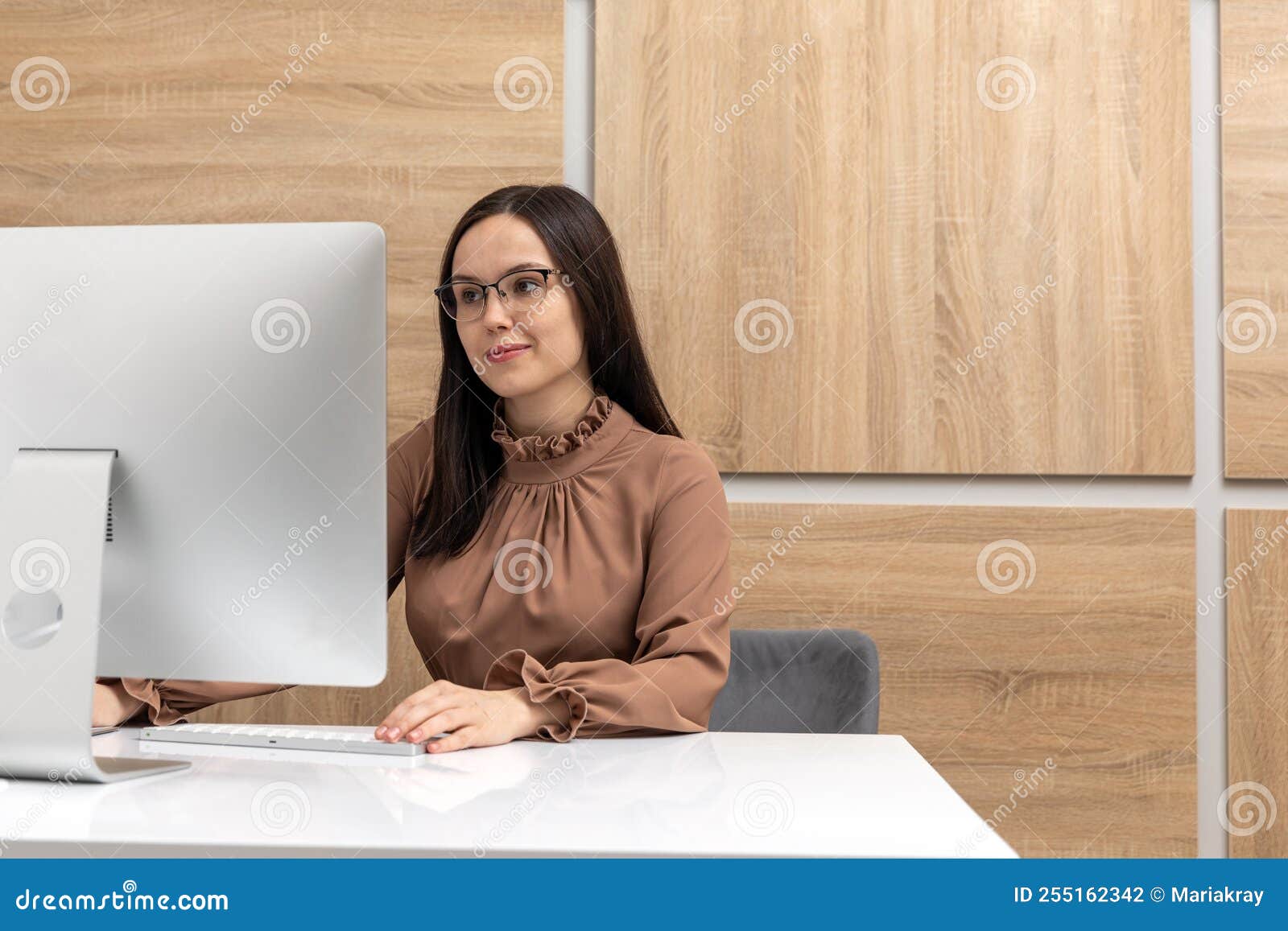 Young Female Secretary Working in Office on Computer Stock Photo ...