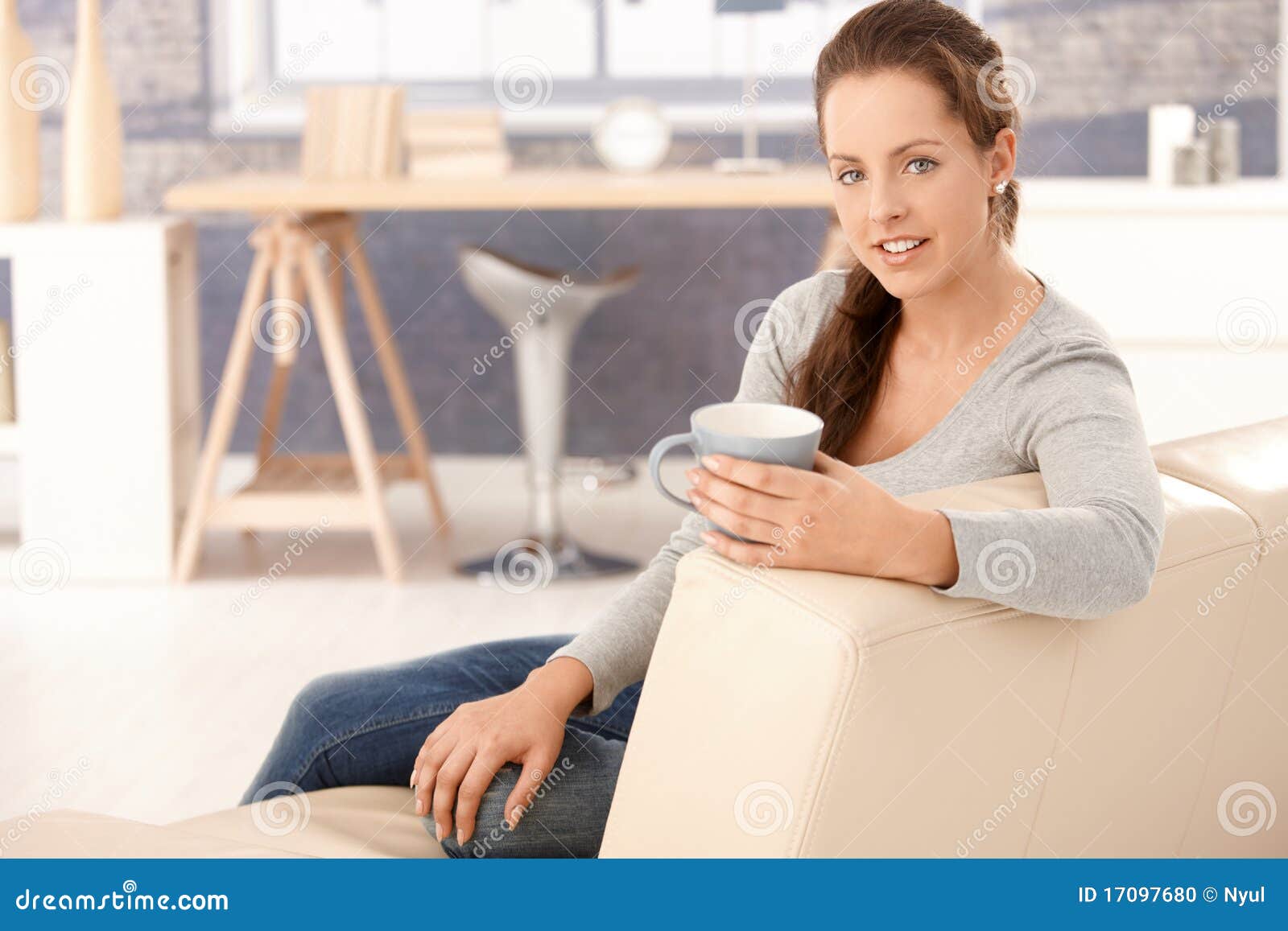 Young Female Sitting on Sofa Drinking Tea Smiling Stock Photo - Image ...