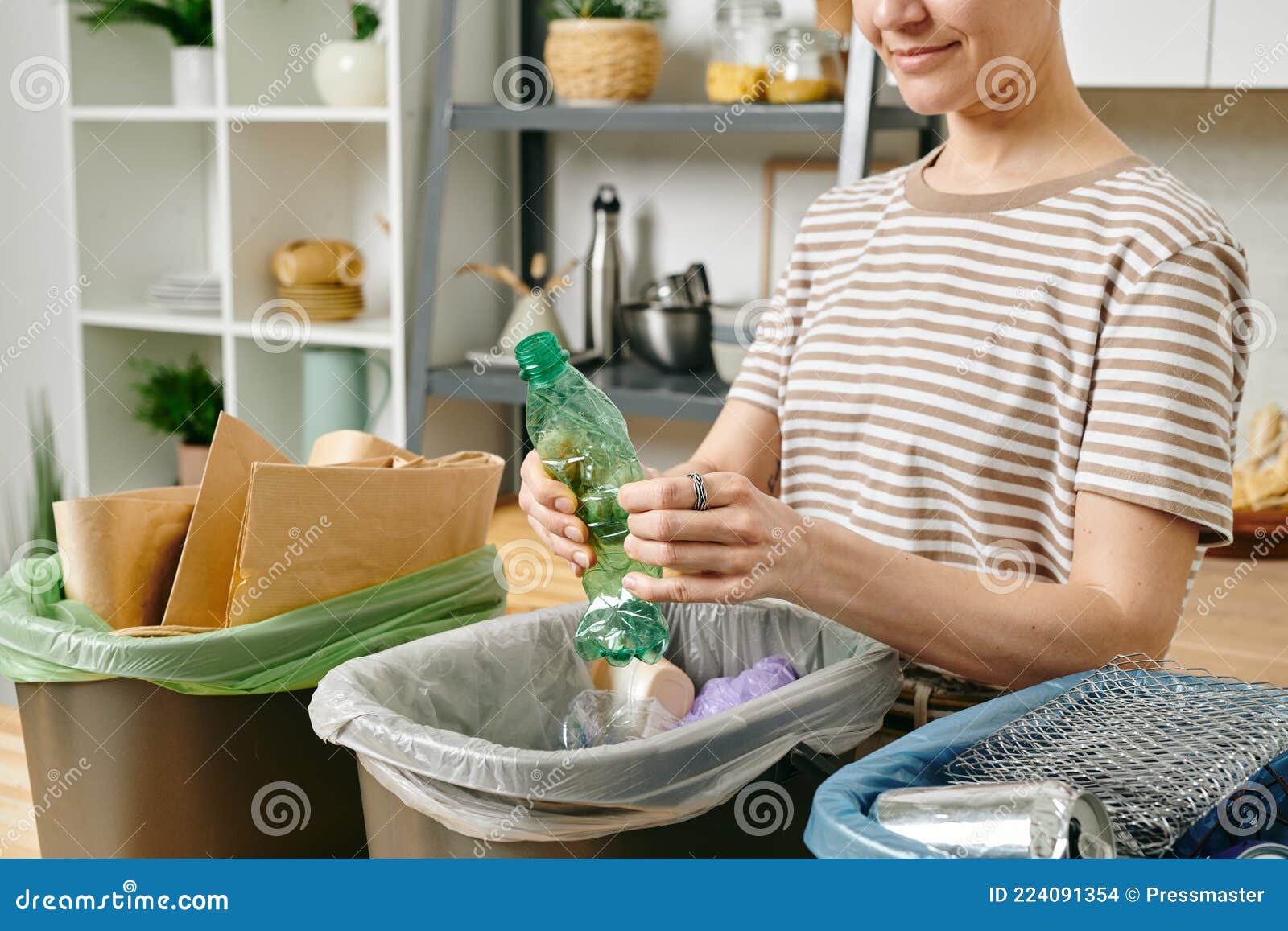 Young Female Smashing Plastic Bottle Over Trash Bin Stock Photo - Image ...