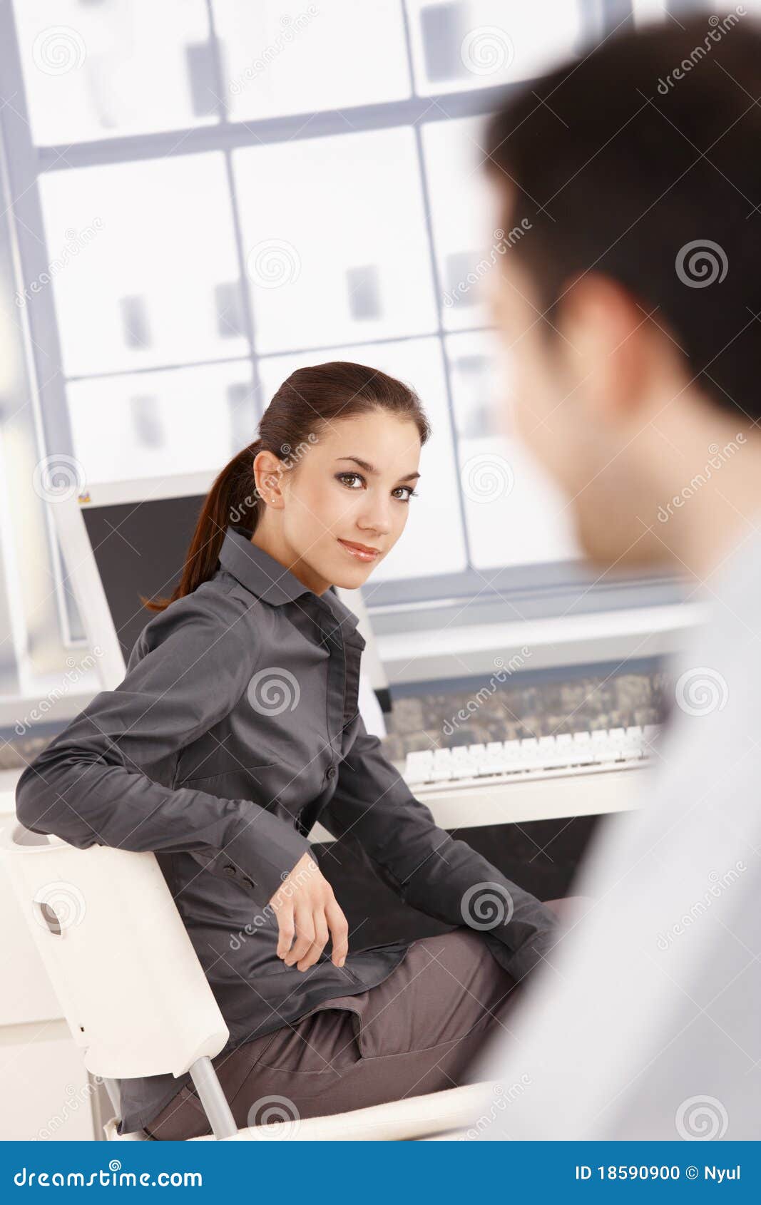 Young Female Smiling at Her Colleague in Office Stock Photo - Image of ...