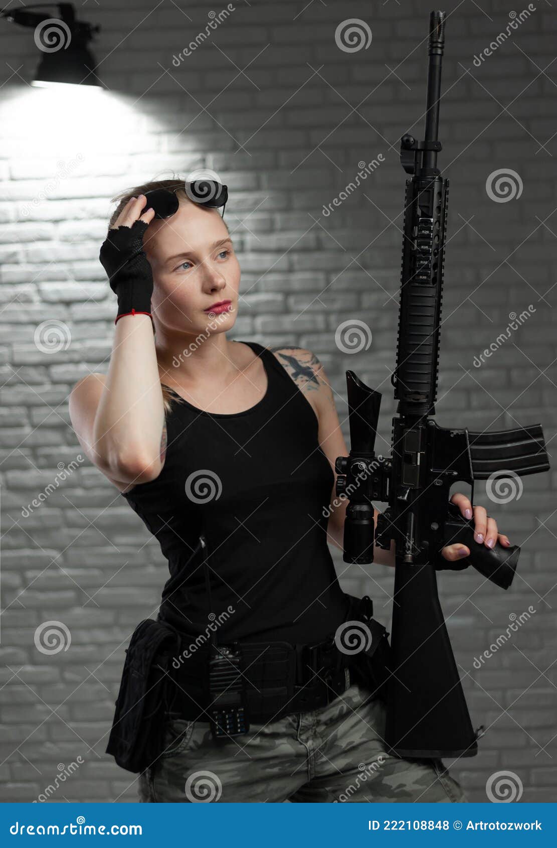 A Young Female Soldier Poses with an Automatic Rifle with a Telescopic ...