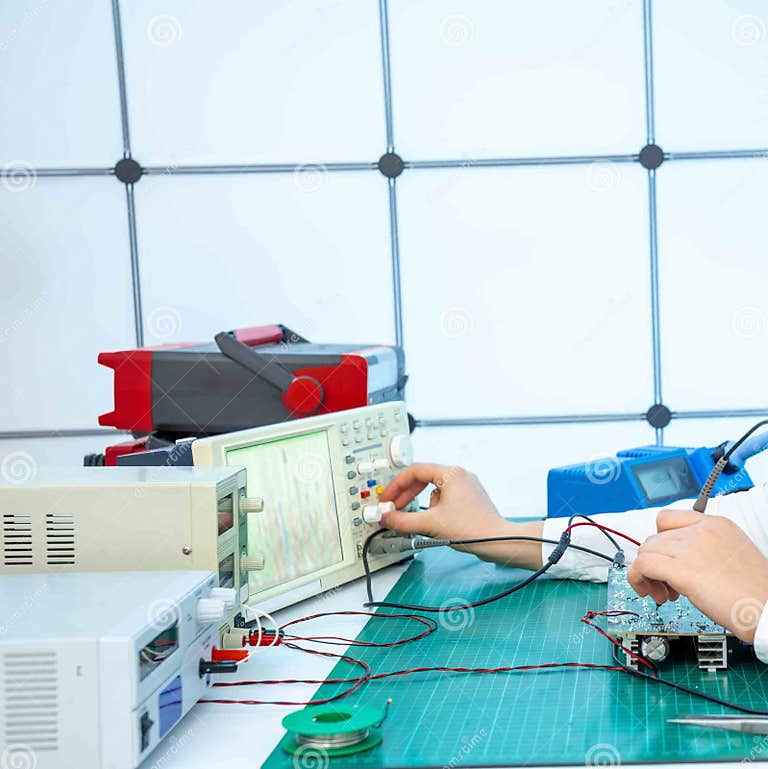 Young Female Student Doing Experiments with an Electronic Device in a ...