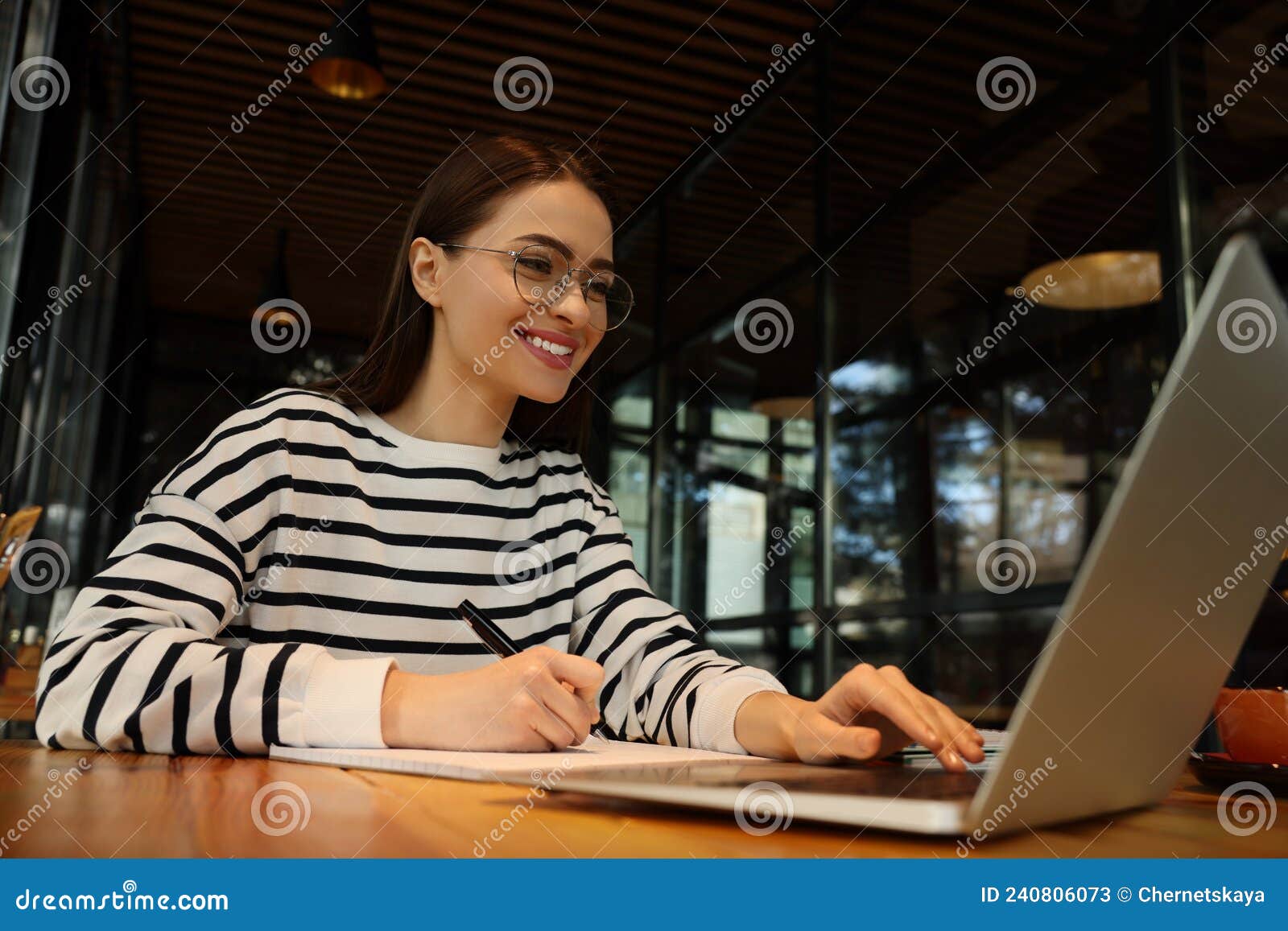 Young Female Student with Laptop Studying at Table in Cafe Stock Image ...