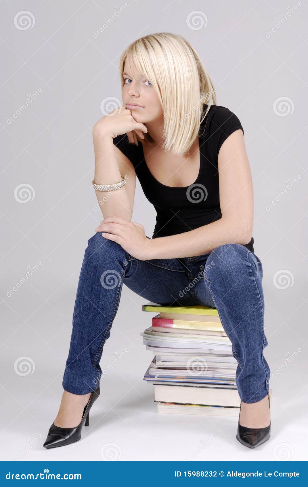 Young Female Student Sitting on Books Stock Photo - Image of white ...