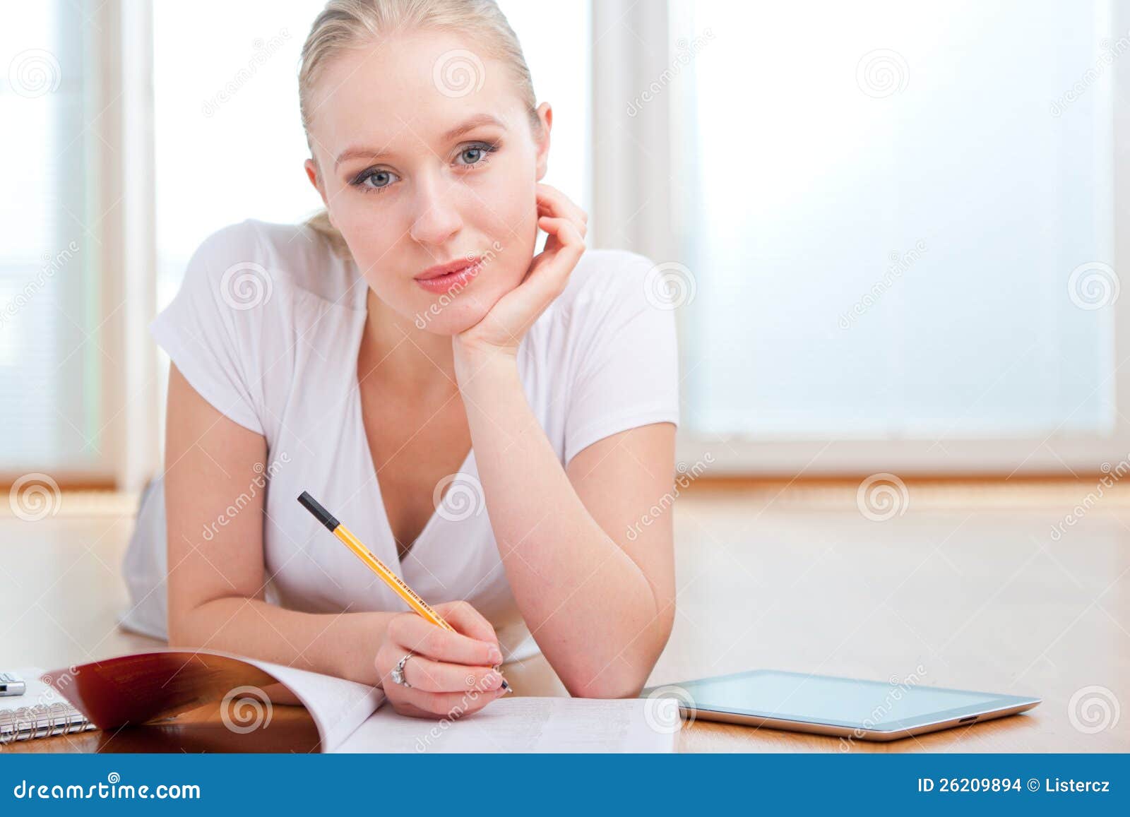 Young Female Student Taking Notes while Studying Stock Photo - Image of ...