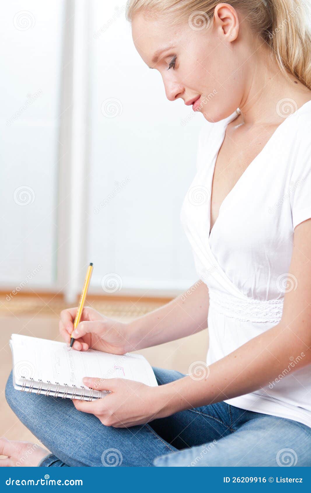 Young Female Student Taking Notes while Studying Stock Photo - Image of ...