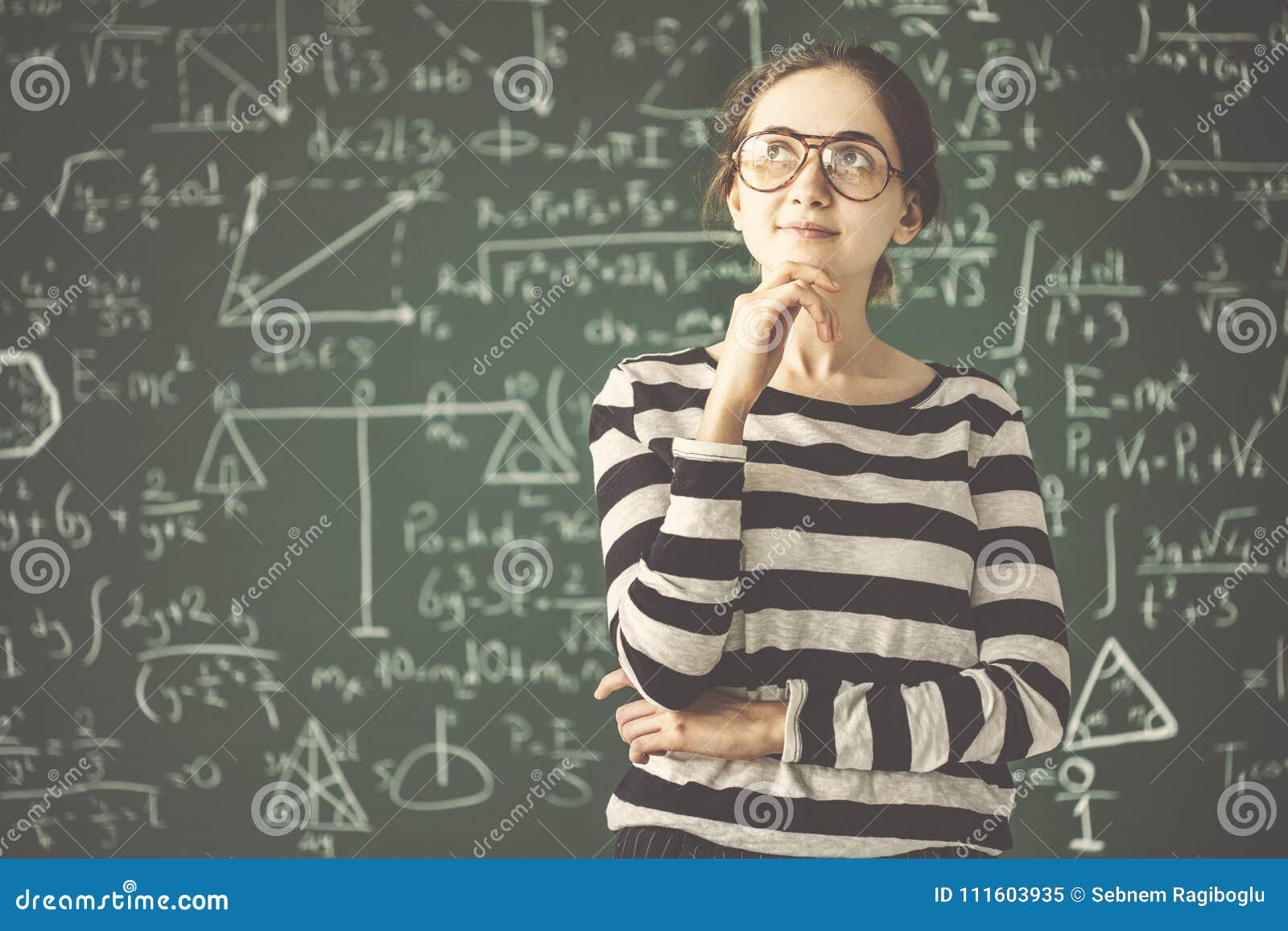 Young Female Student Thinking in Front of Classroom Board Stock Image ...