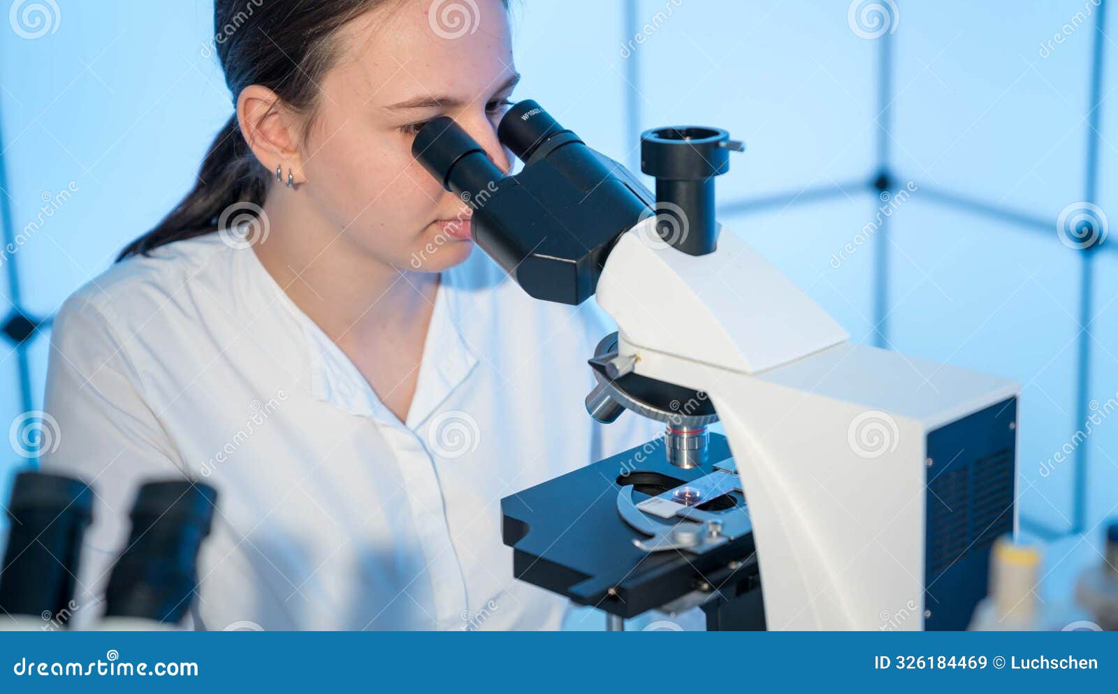 Young Female Student Working in a Microbiology Laboratory with a ...