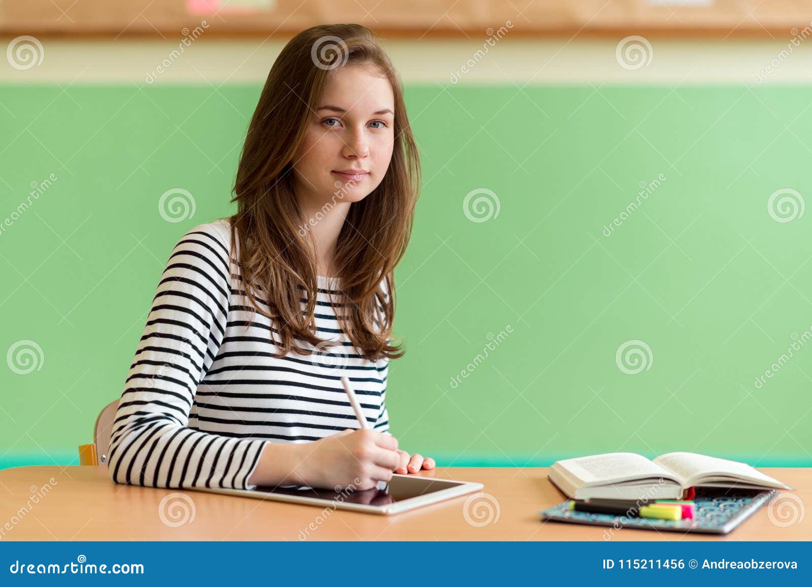 Young Female Student Writing Notes Using Digital Tablet during Class ...