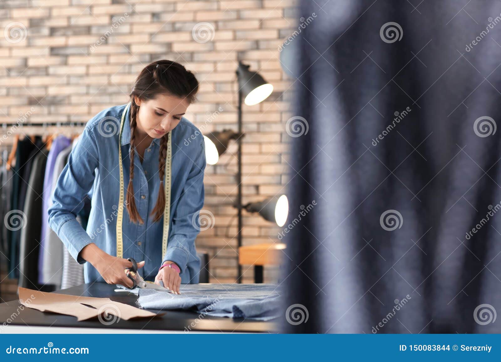 Young Female Tailor Cutting Fabric in Atelier Stock Photo - Image of ...