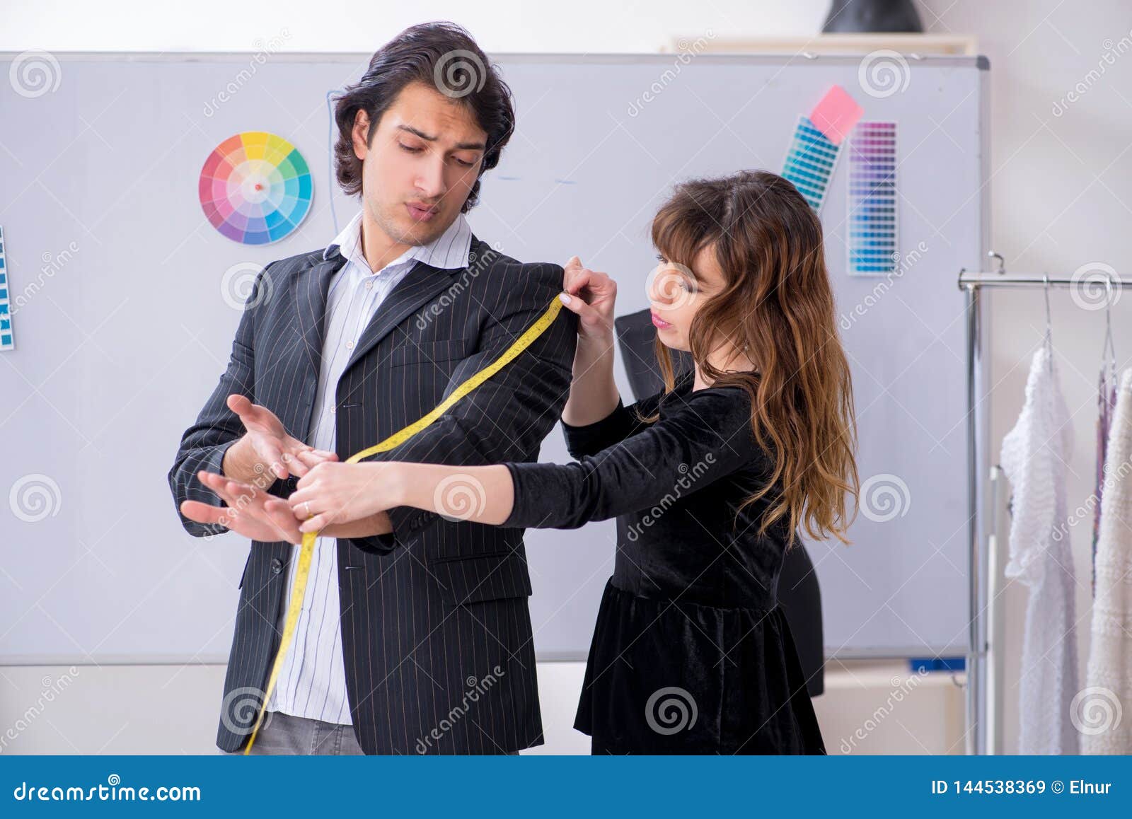The Young Female Tailor Taking Measurements for Formal Suit Stock Image ...