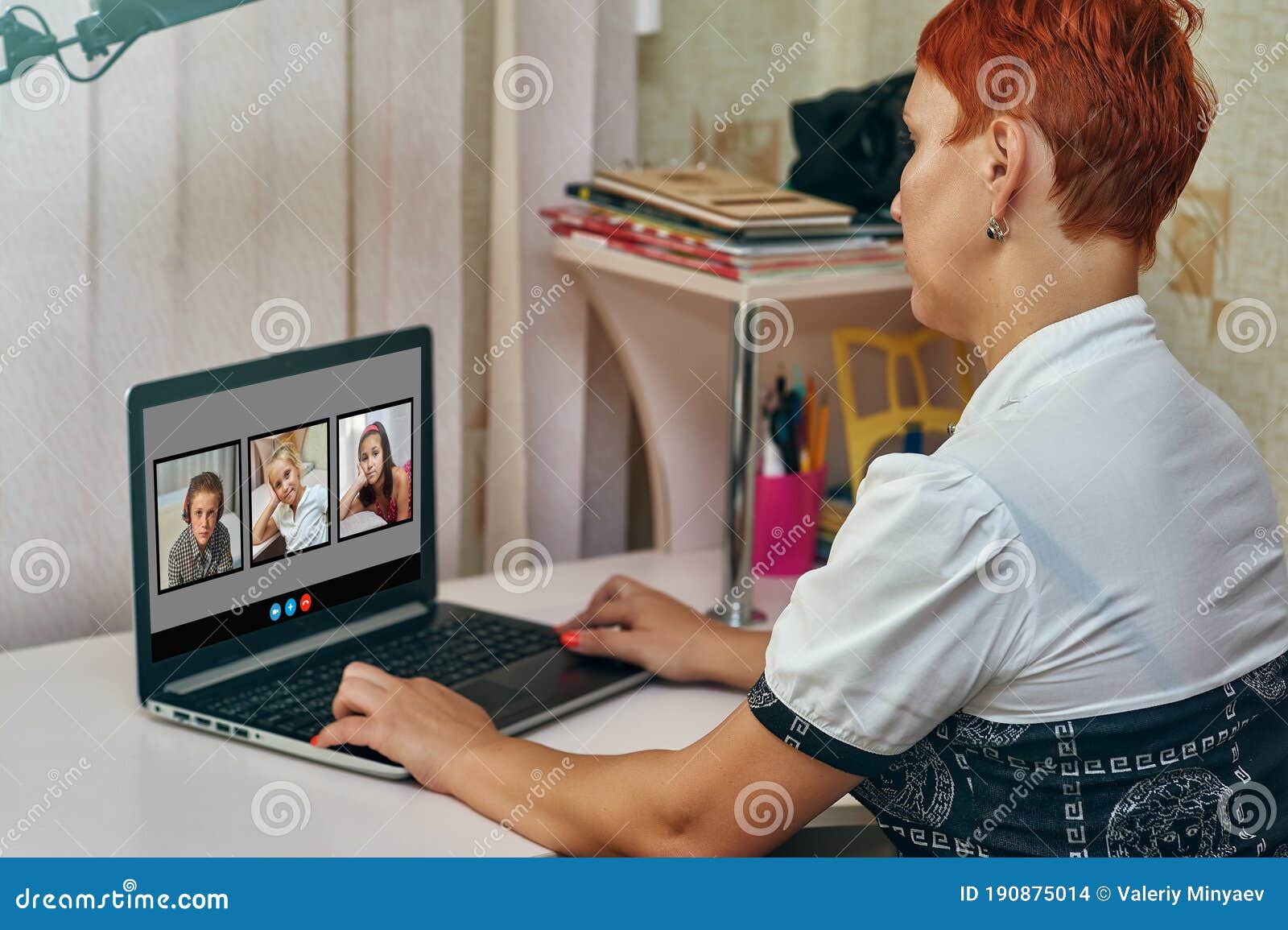 A Female Teacher Leads an Online Lesson with Students from Her Home ...