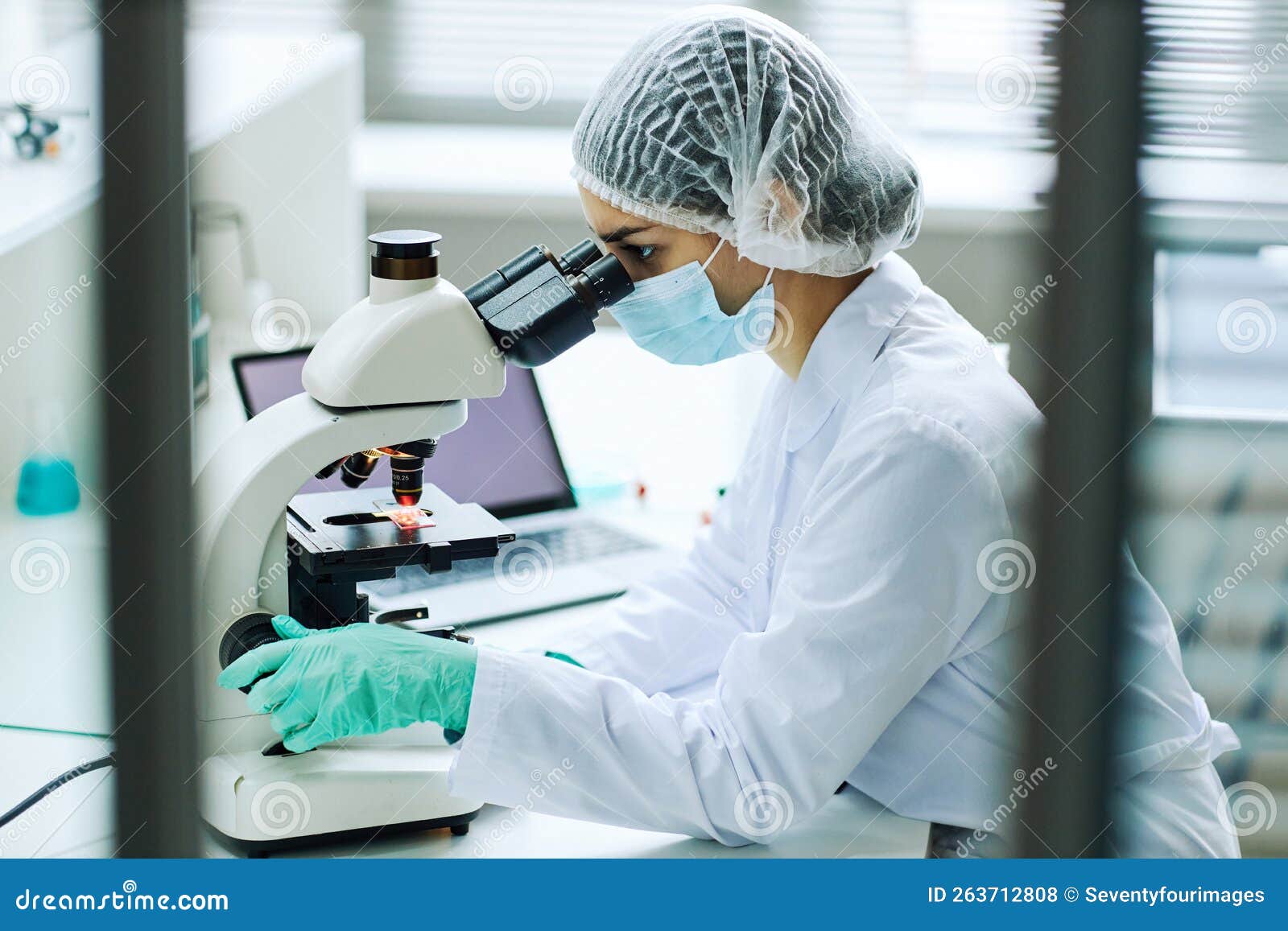 Young Female Technician Looking in Microscope Working in Lab Stock ...