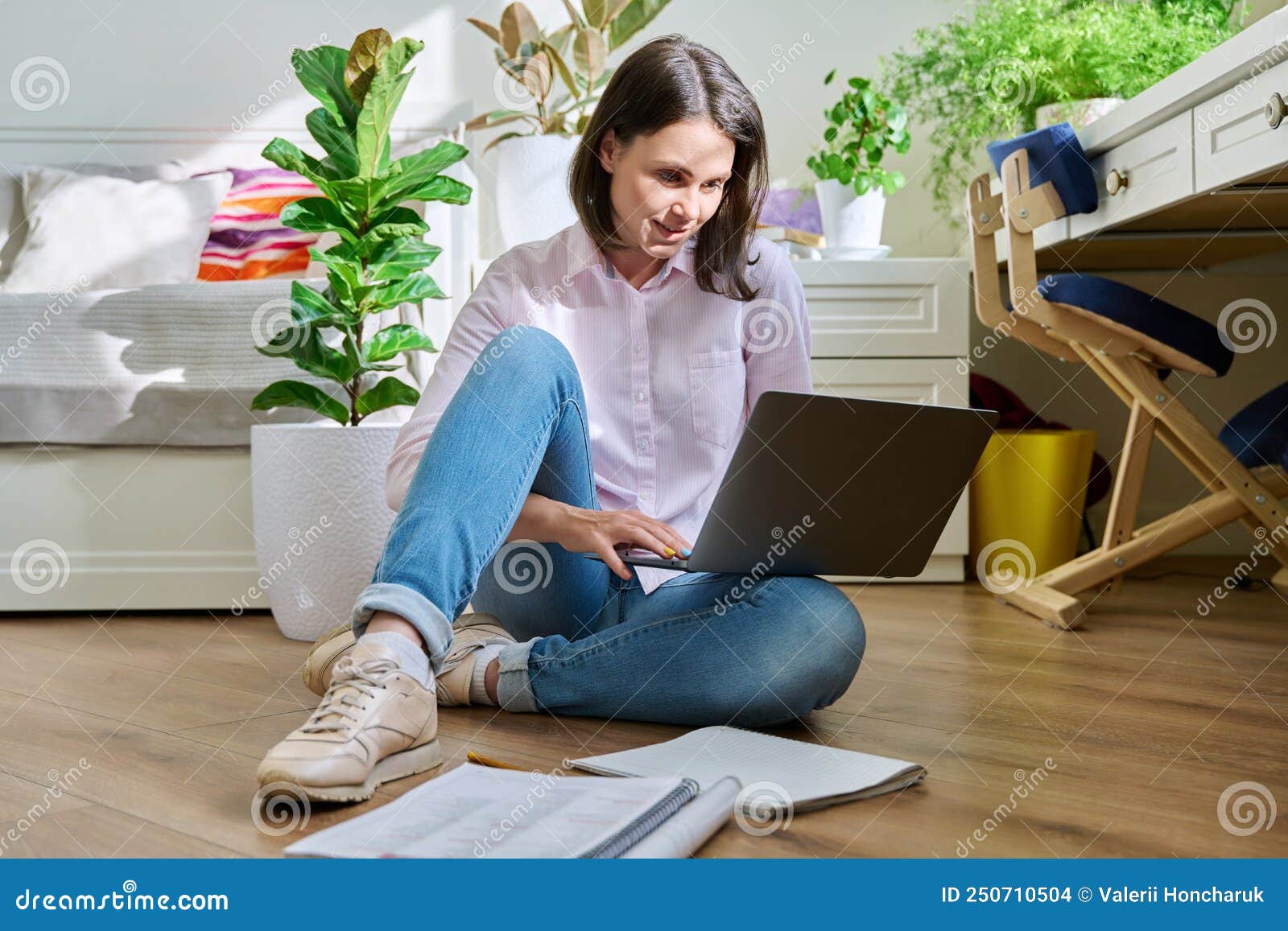 Young Female University Student Studying at Home Sitting on Floor Using ...