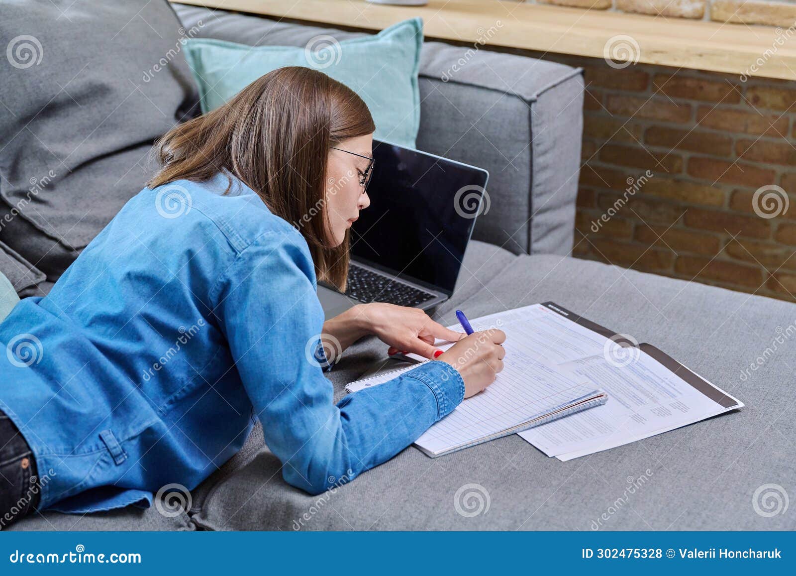 Young Female University Student Studying at Home, Using Laptop Computer ...