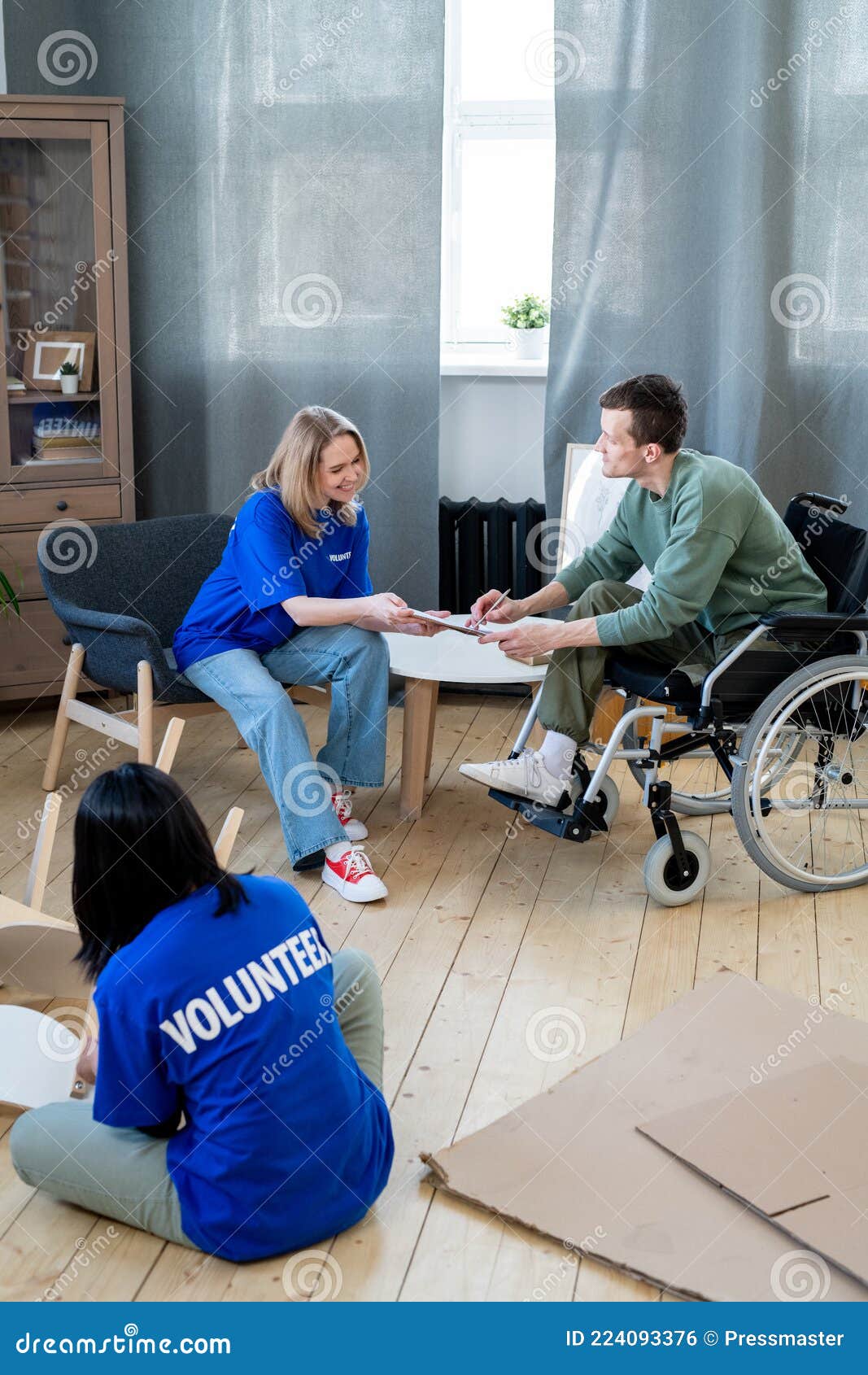 Young Female Volunteer and Disabled Man Discussing Document Stock Photo ...