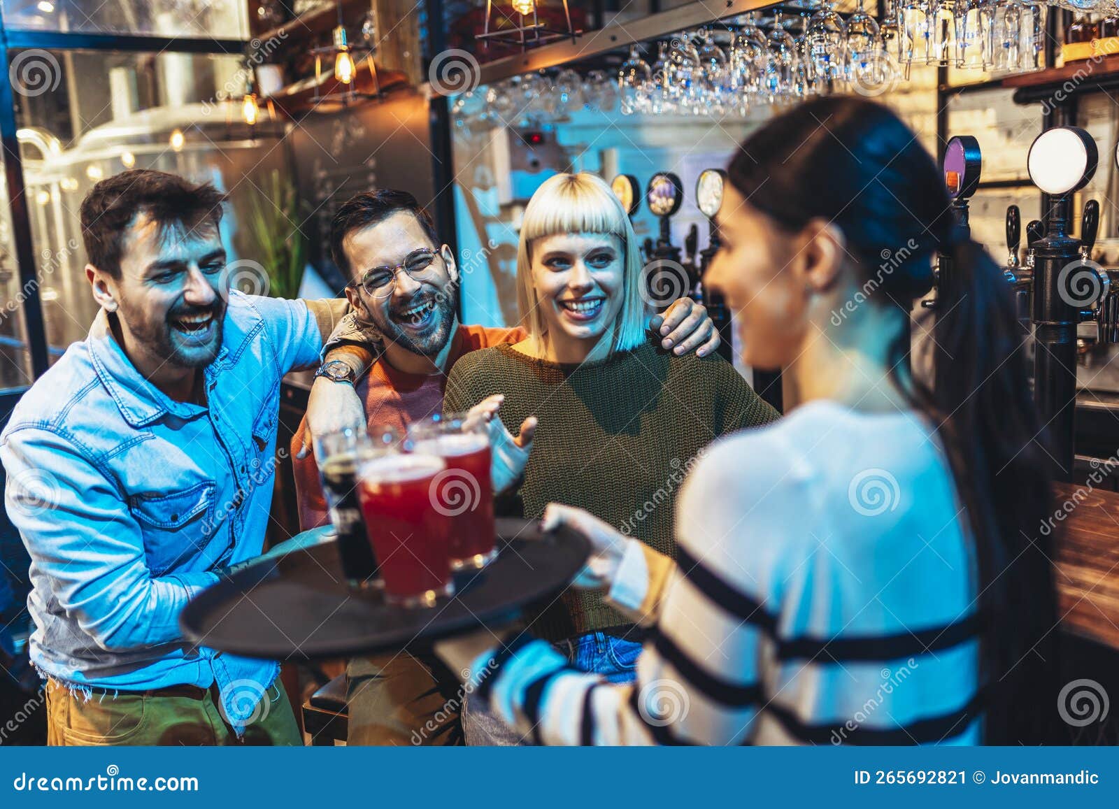Female Waitress or Bartender Serving Drinks in a Bar Carrying a Tray ...