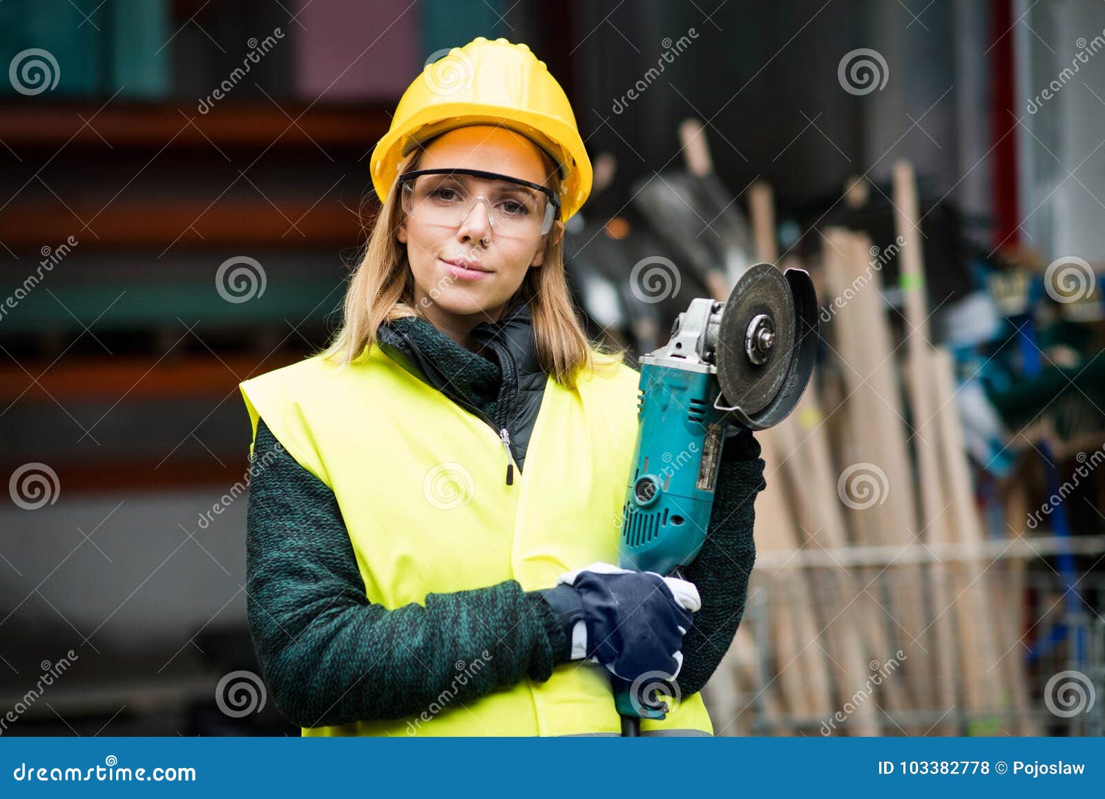 Female Worker with Angle Grinder in a Warehouse. Stock Photo - Image of ...