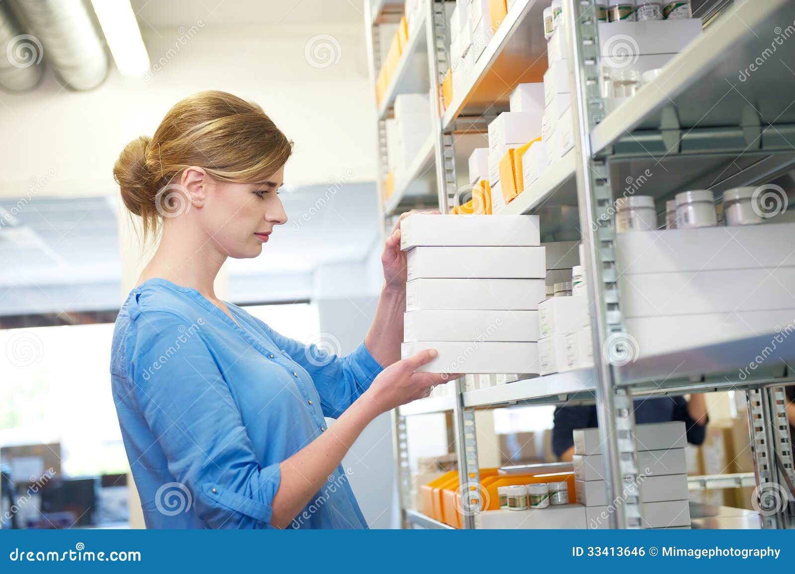 Young Female Worker Holding Boxes in Warehouse Stock Photo - Image of ...