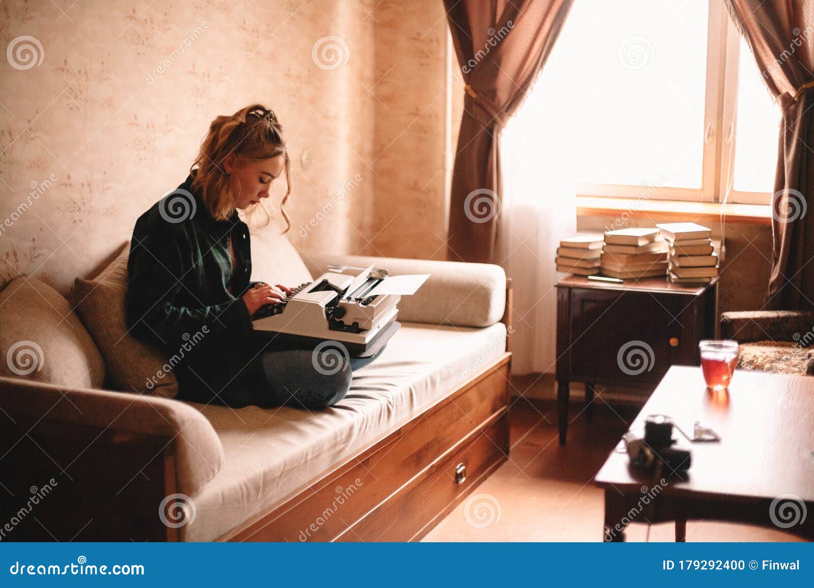 Young Female Writer Using Typewriter while Sitting on Sofa Stock Photo ...