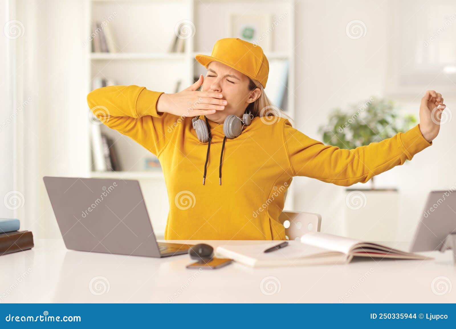 Young Female Yawning in Front of a Laptop Computer Stock Photo - Image ...