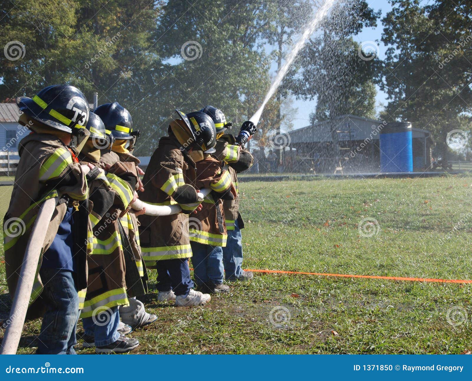 Young fire fighters stock photo. Image of helment, hose - 1371850