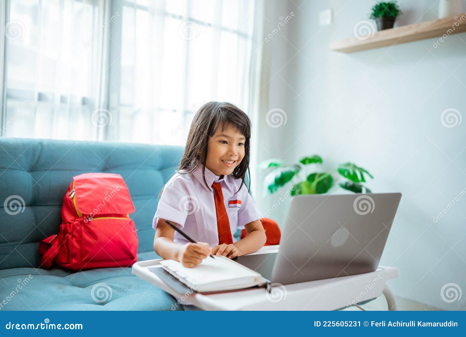 First Grade School Student with Uniform during Online Class Study with ...