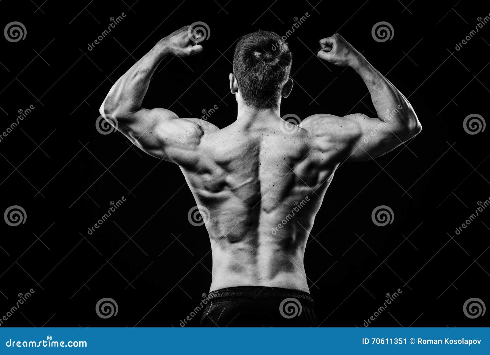Young and Fit Bodybuilder Athlete Demonstrates Biceps Back View on ...