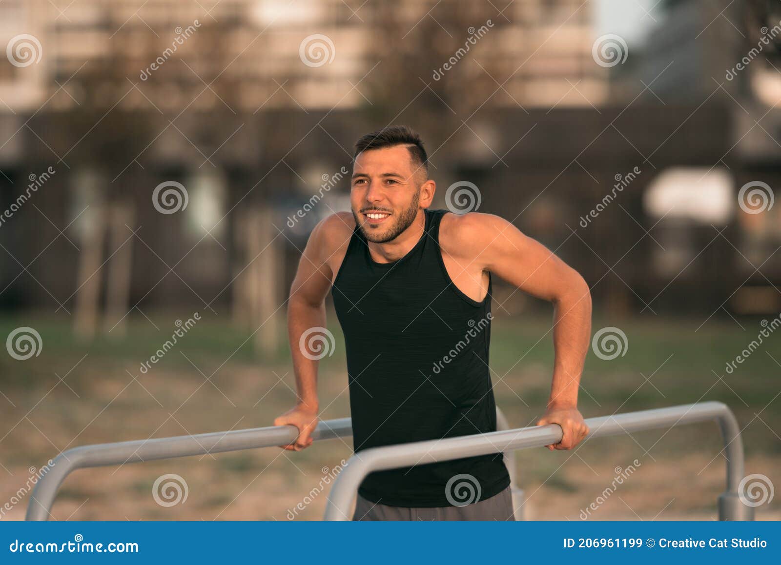 Young Fit Man Doing Triceps Dips on Parallel Bars Outdoors. Doing ...