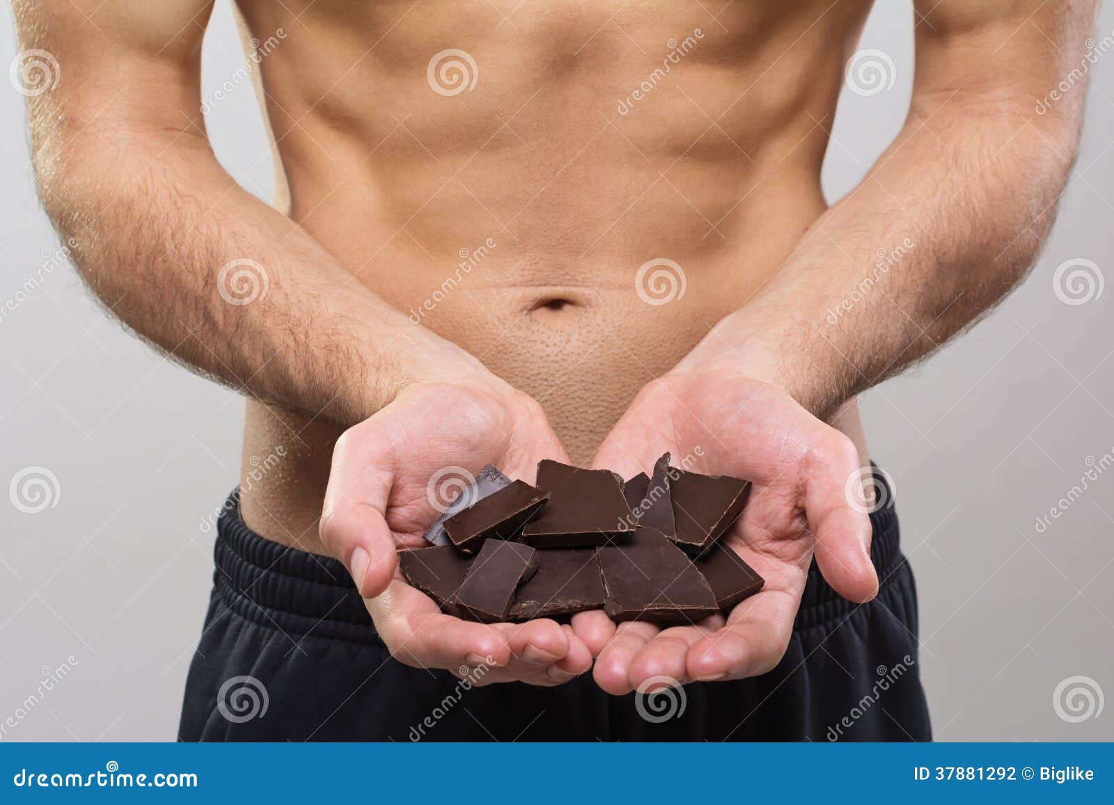 Young Fit Man Holding Dark Chocolate Pieces Stock Photo - Image of body ...