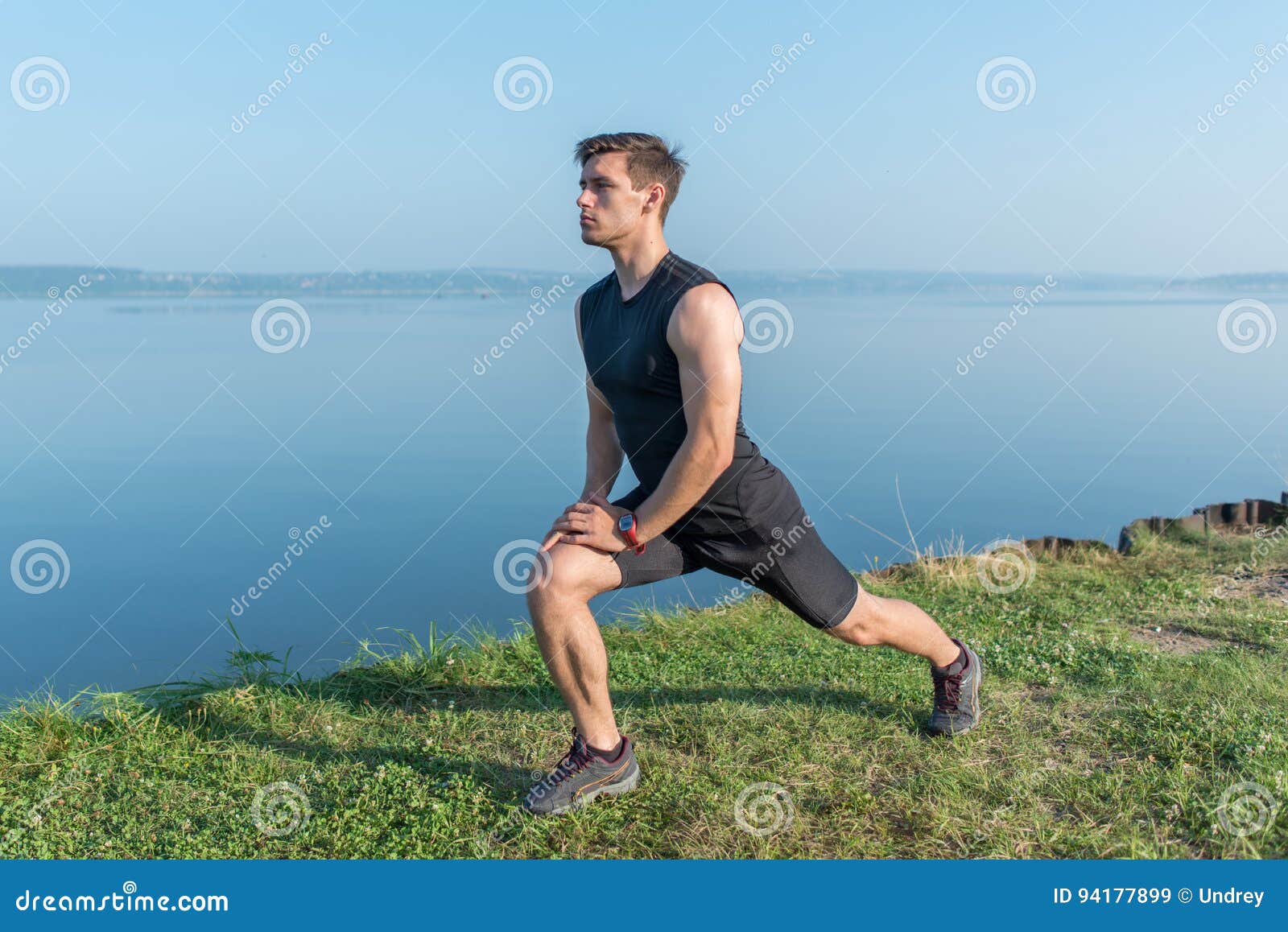 Young Fit Man Stretching Legs Outdoors Doing Forward Lunge. Stock Image ...